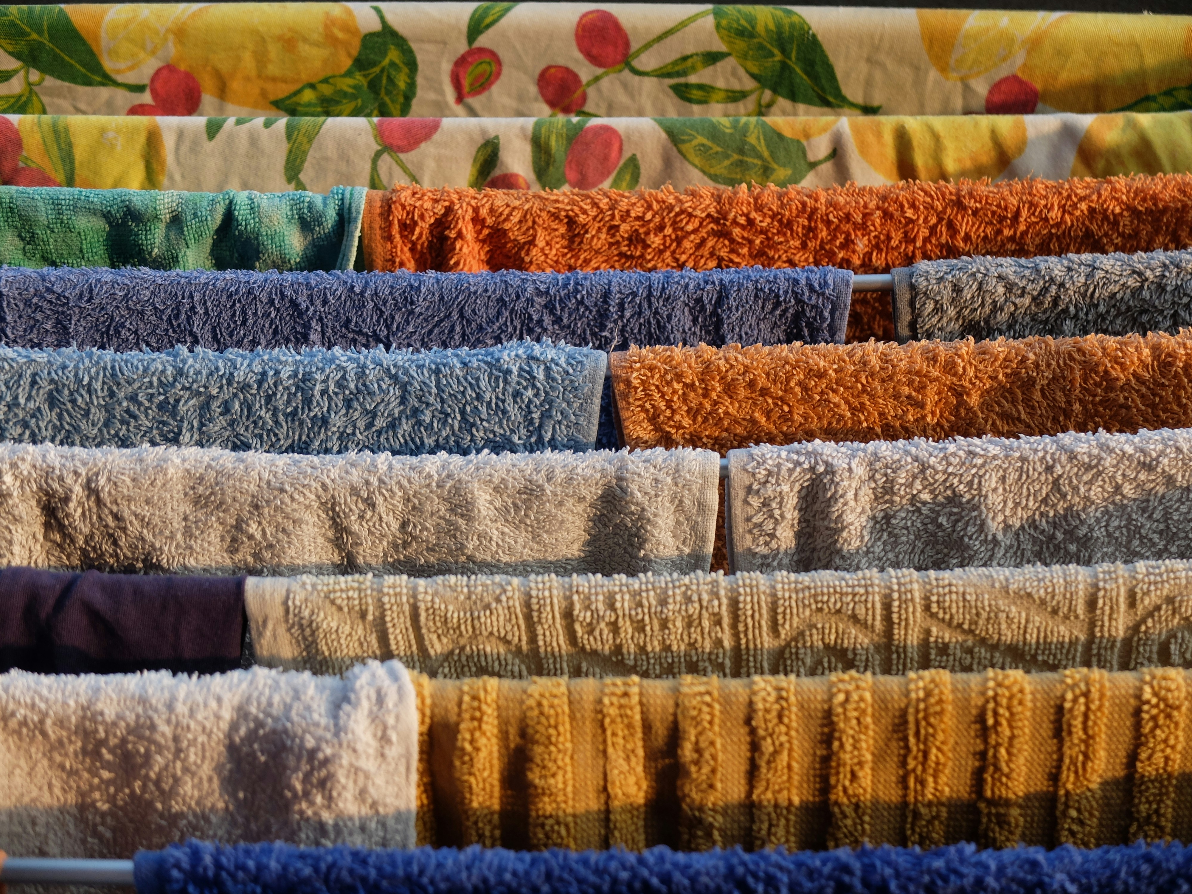 A vibrant array of neatly arranged towels in various colors and textures, showcasing their unique patterns and materials.