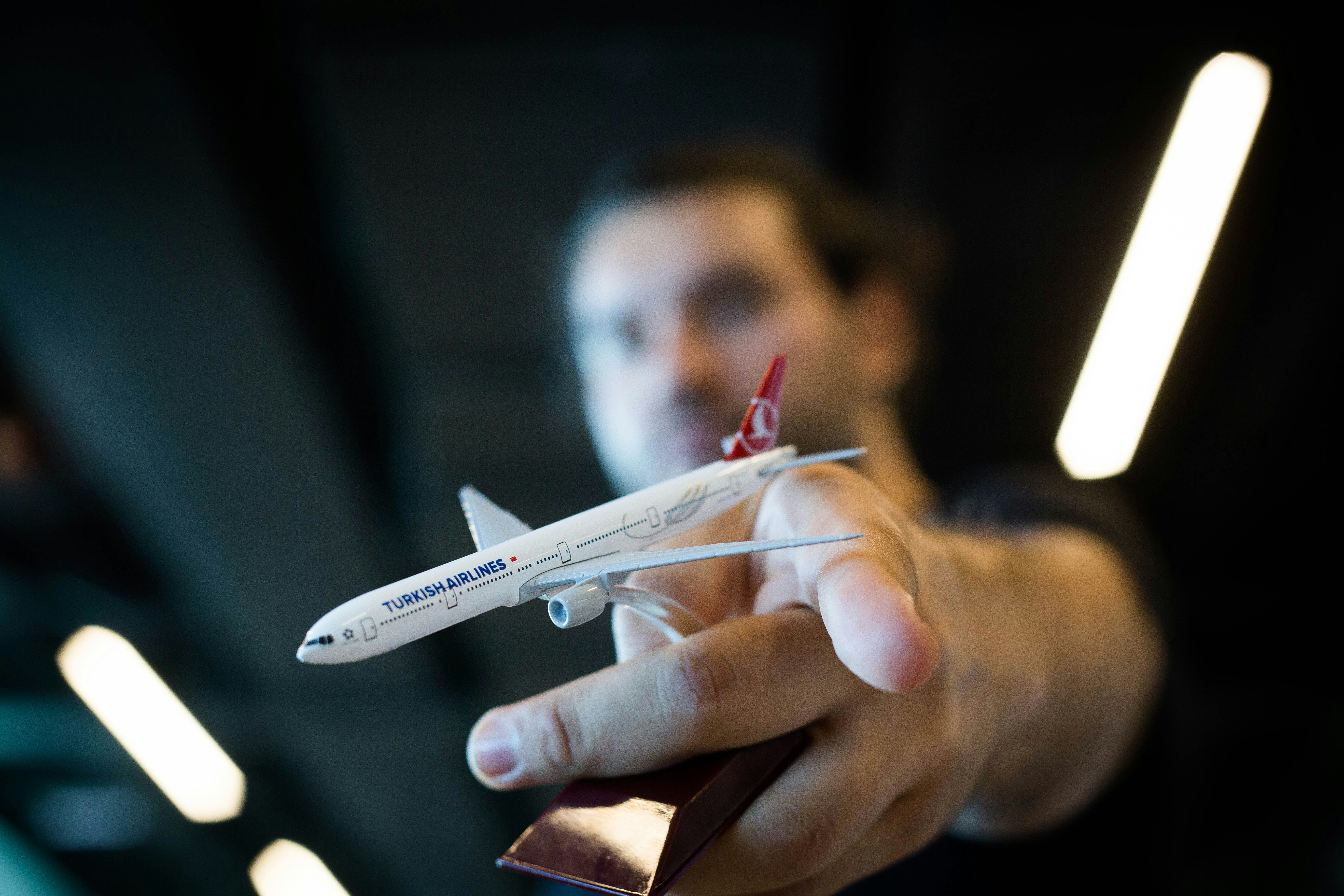 Model airplane in focus: a hand-extended cockpit closer view