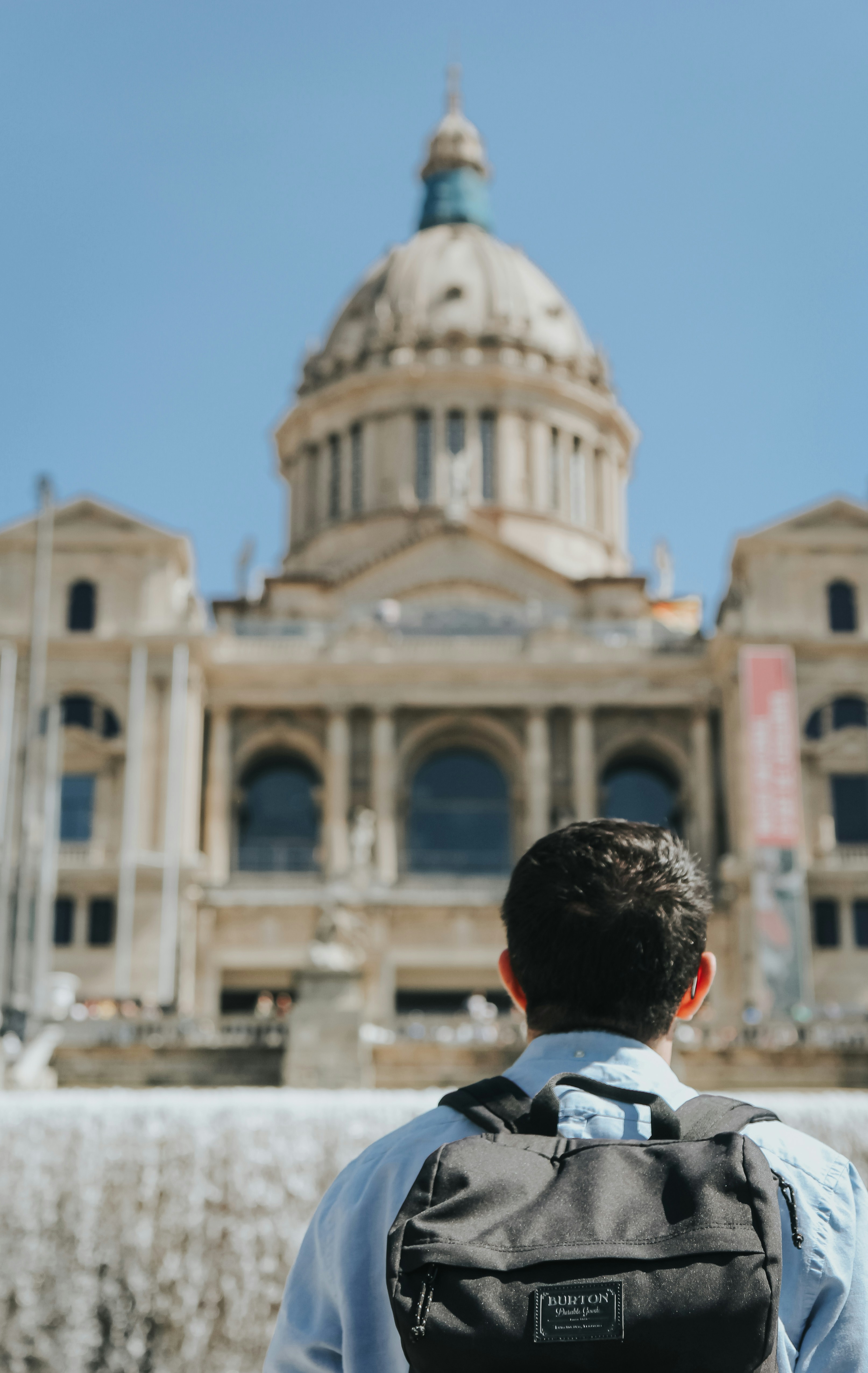 Traveler Before the Grand Facade