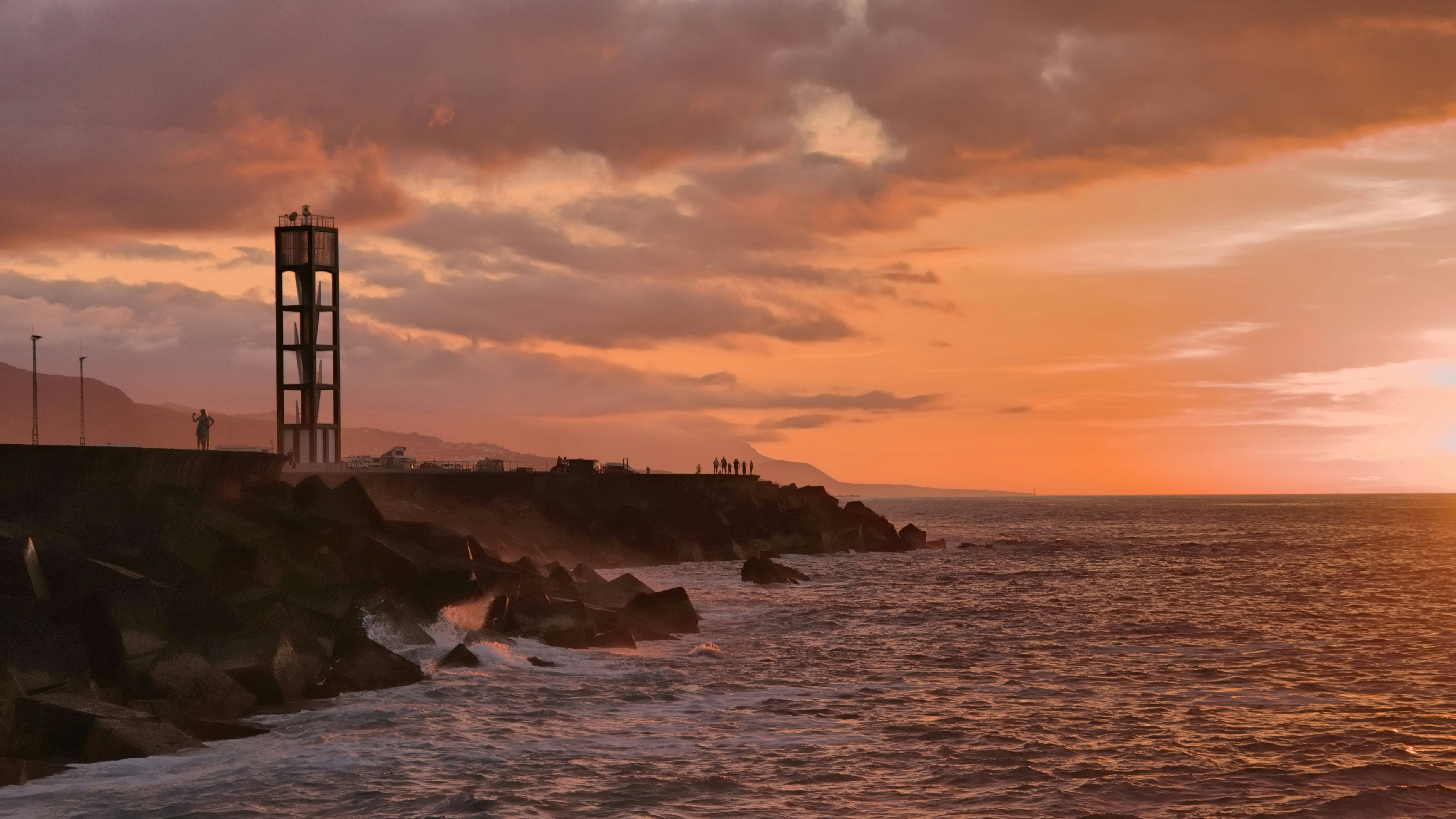 Black tower building near seashore under orange skies photo – Free ...