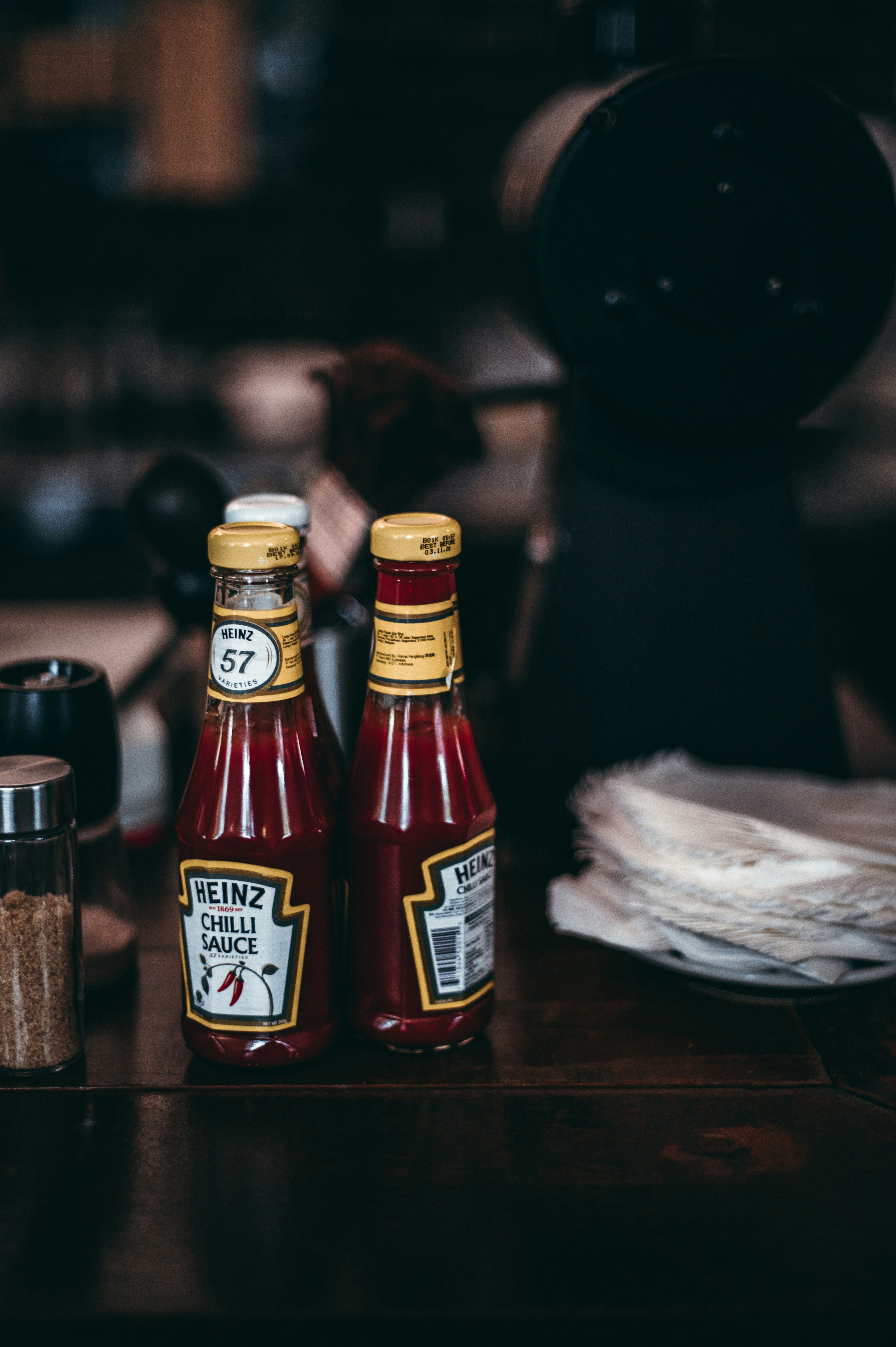 Dimly Lit Countertop Duo: Heinz Ketchup Bottles in Focus