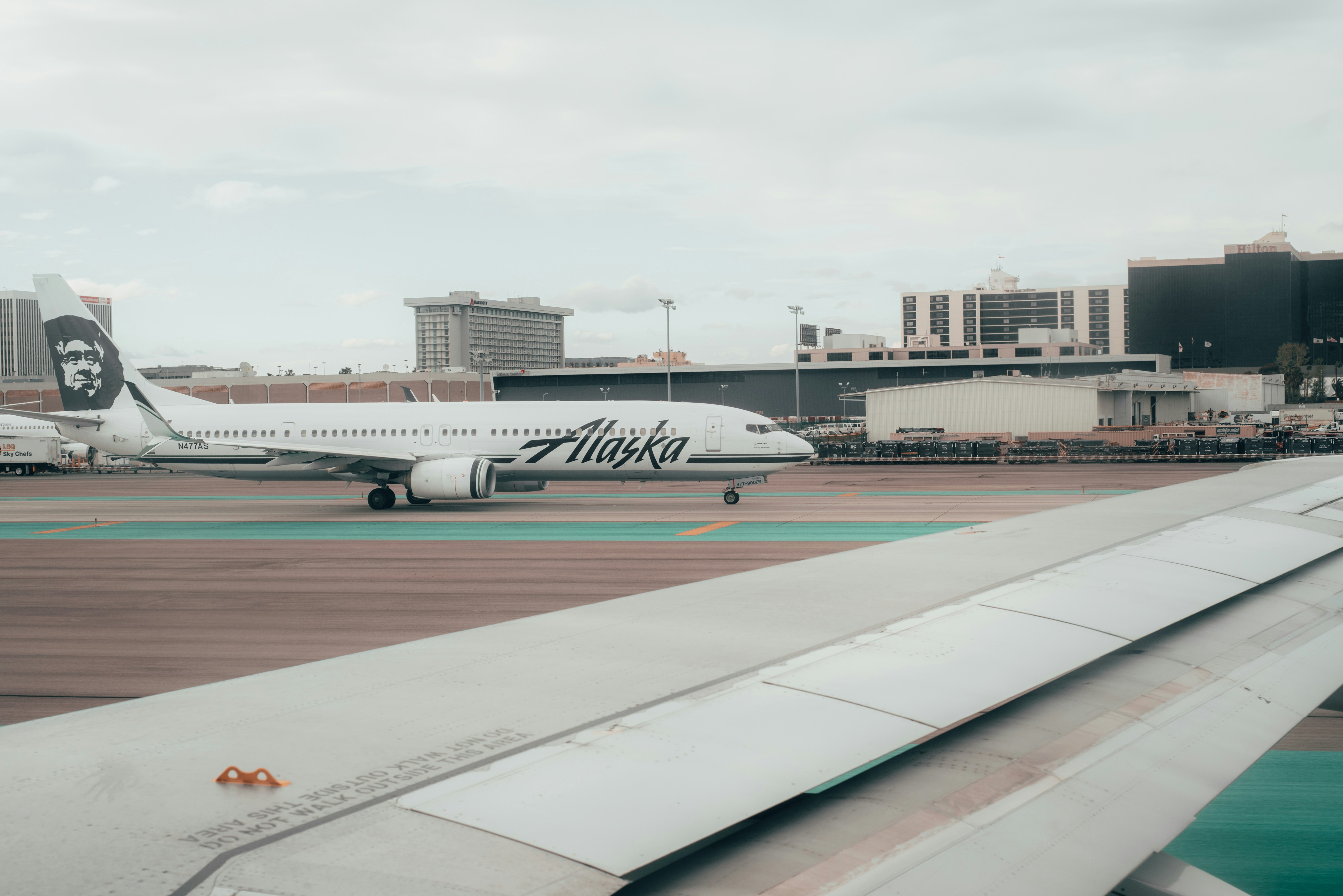 white and gray Alaska plane at airport during daytime