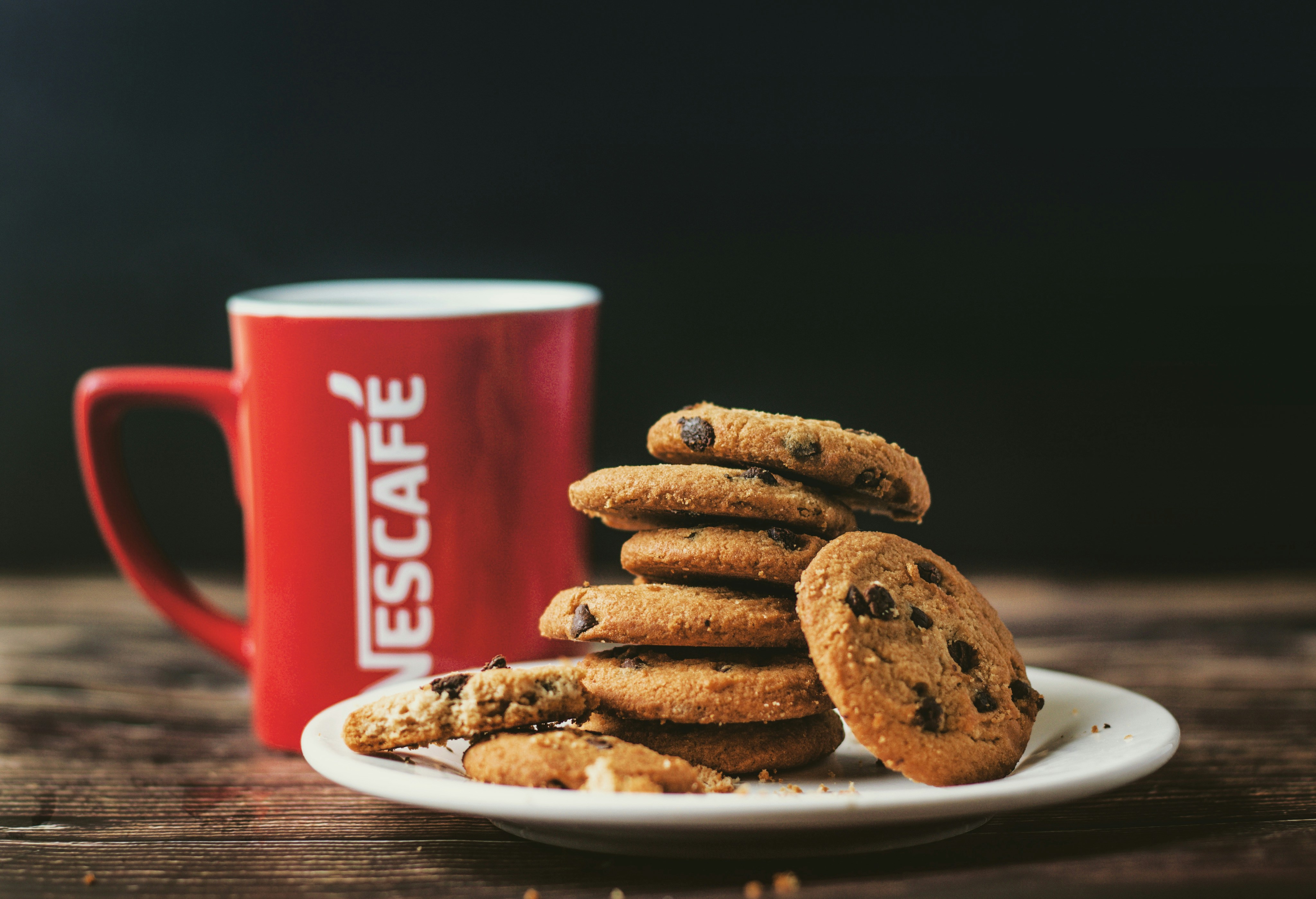 Pile of cookies beside Nescafe ceramic mug photo – Free Biscuit Image ...