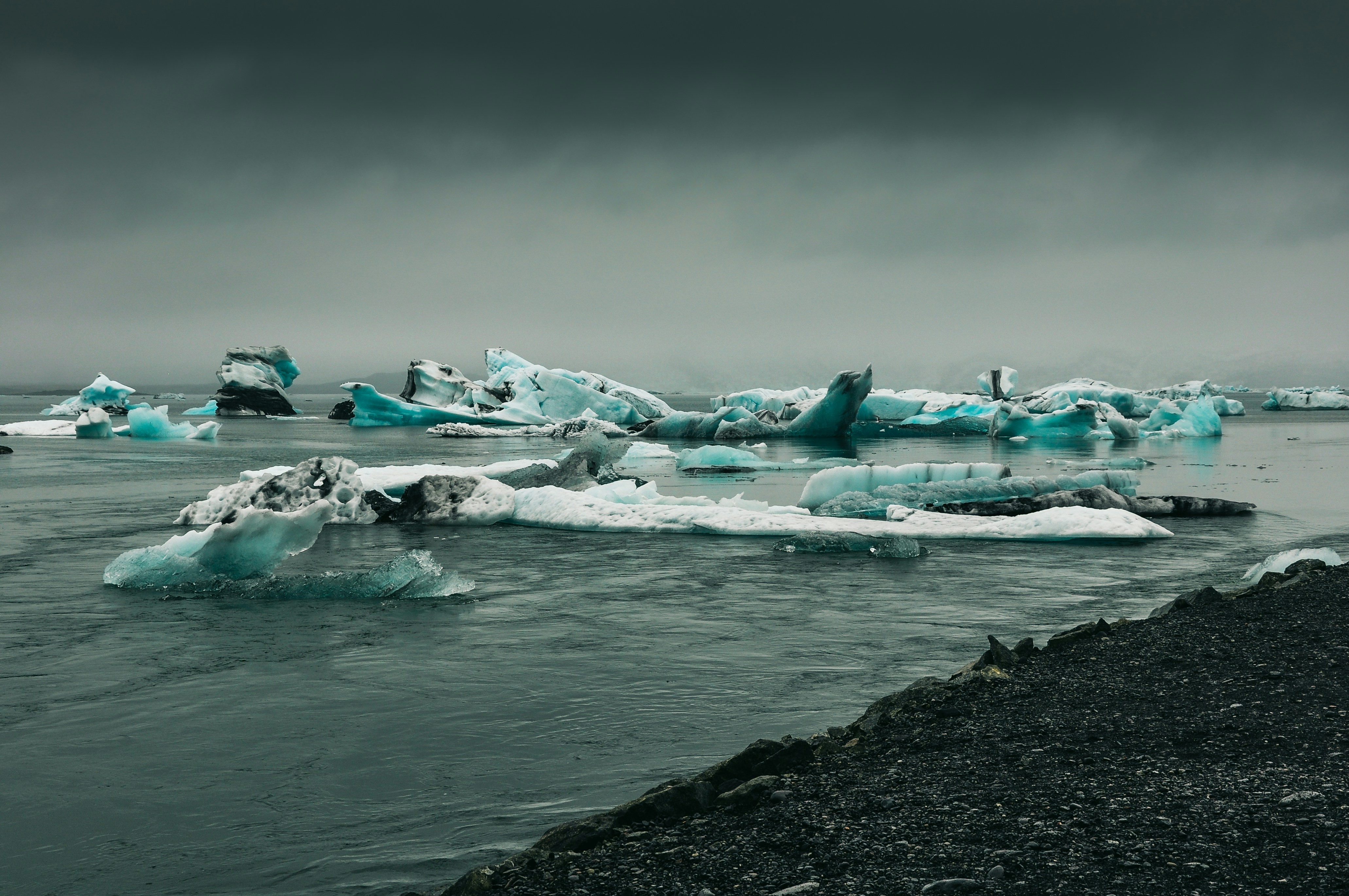 Turquoise Ice Floes Drift Across the Quiet Arctic Sea