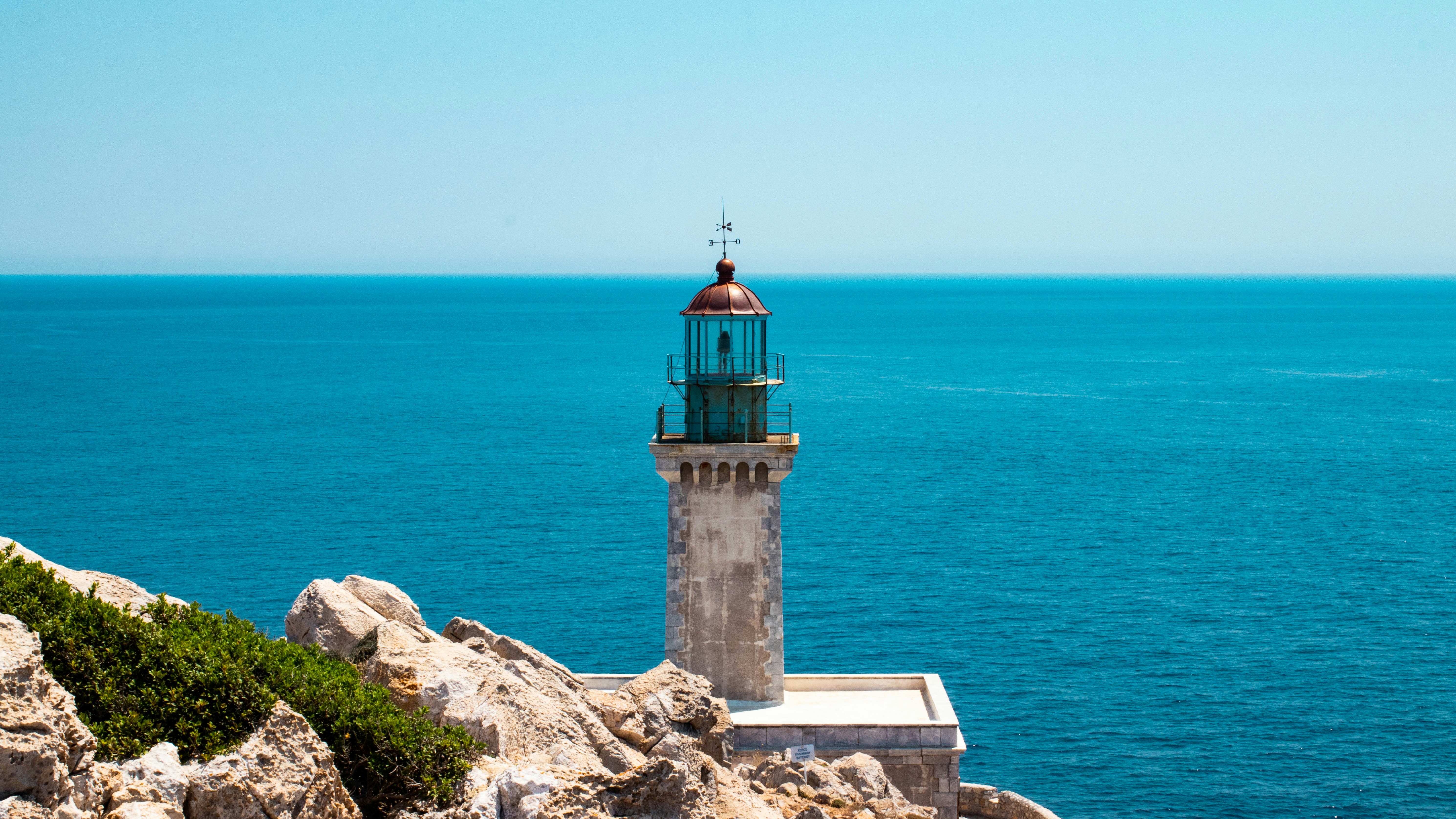 Gray lighthouse under clear blue sky during daytime photo – Free ...