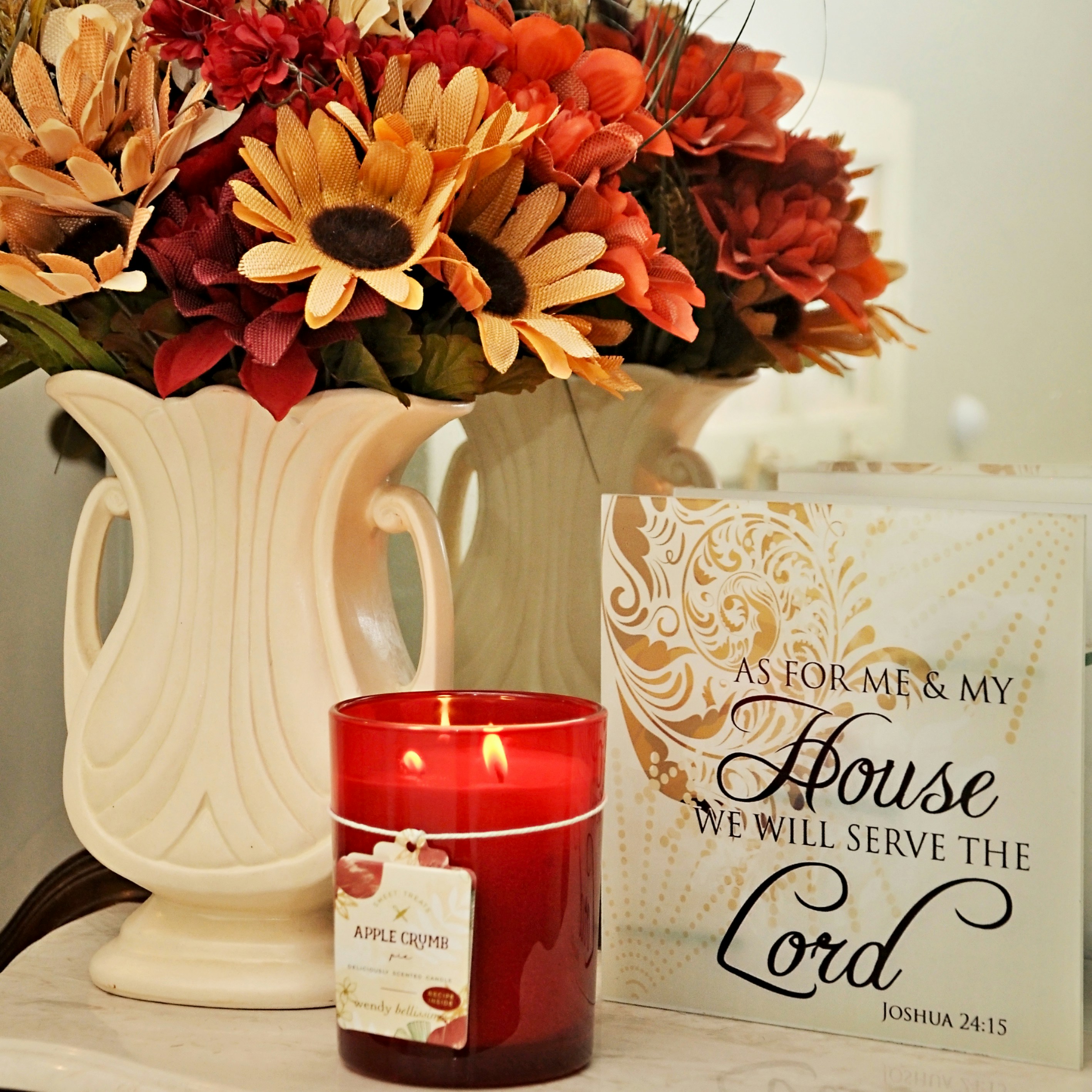 Crimson Candle Amid Autumn-Hued Florals and a Scriptural Card