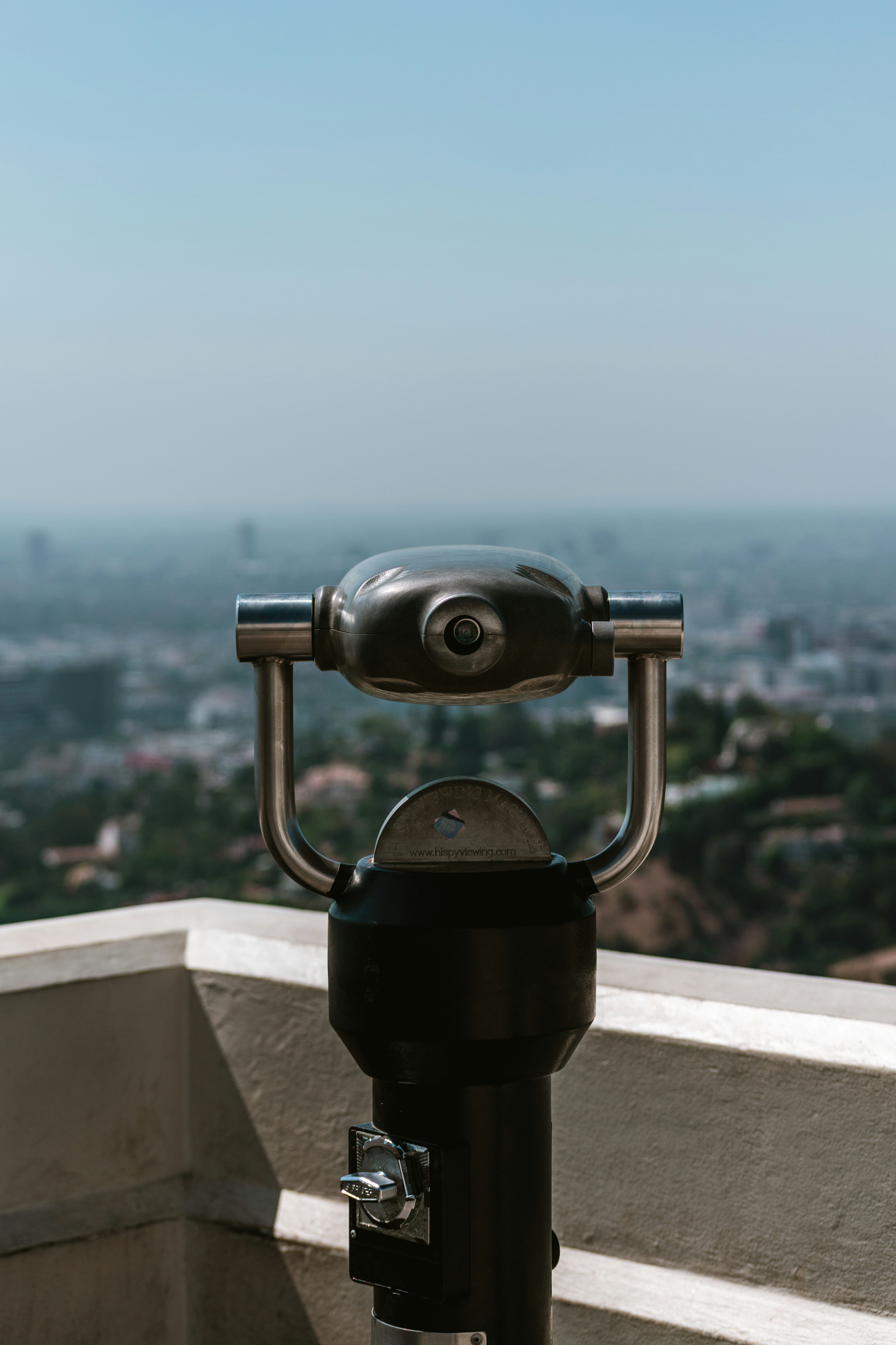 photography of black coin-operated telescope