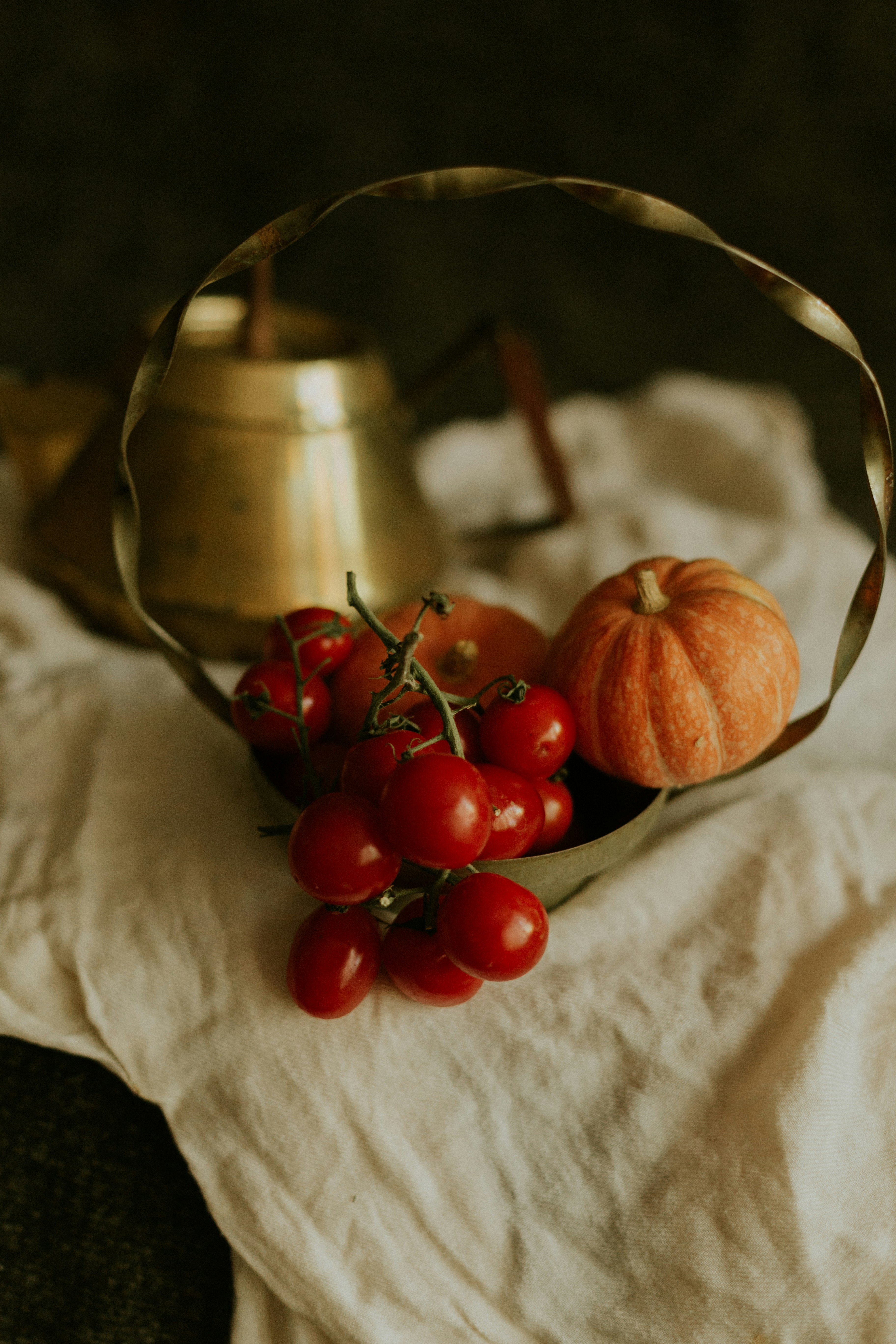 Ringed Harvest: A Quiet Still Life of Tomatoes and a Tiny Pumpkin