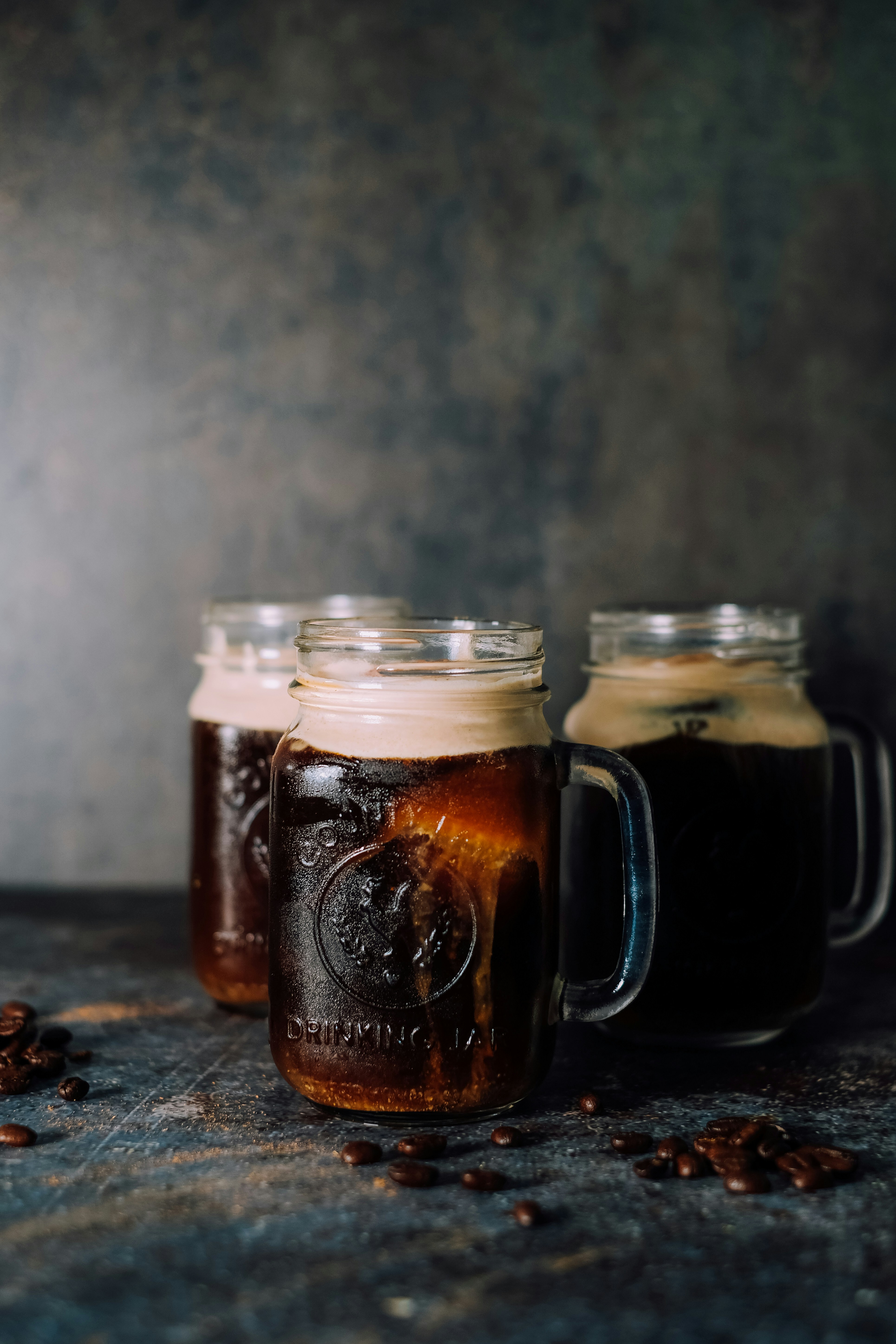 Pumpkin Cream Cold Brew Coffee into Glass Rustic Earthy Background