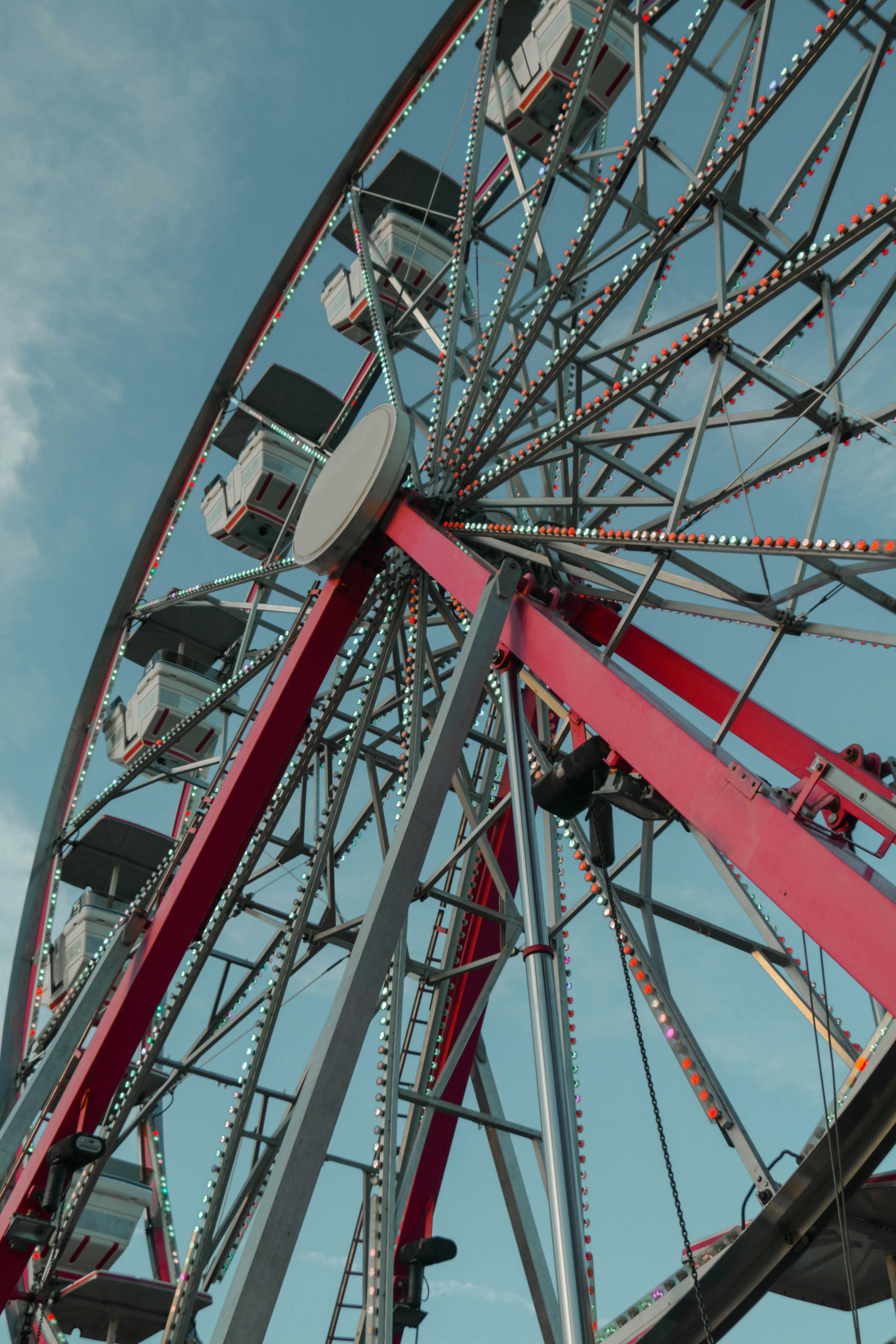 Macro photography of red and gray ferris wheel under blue and white sky ...