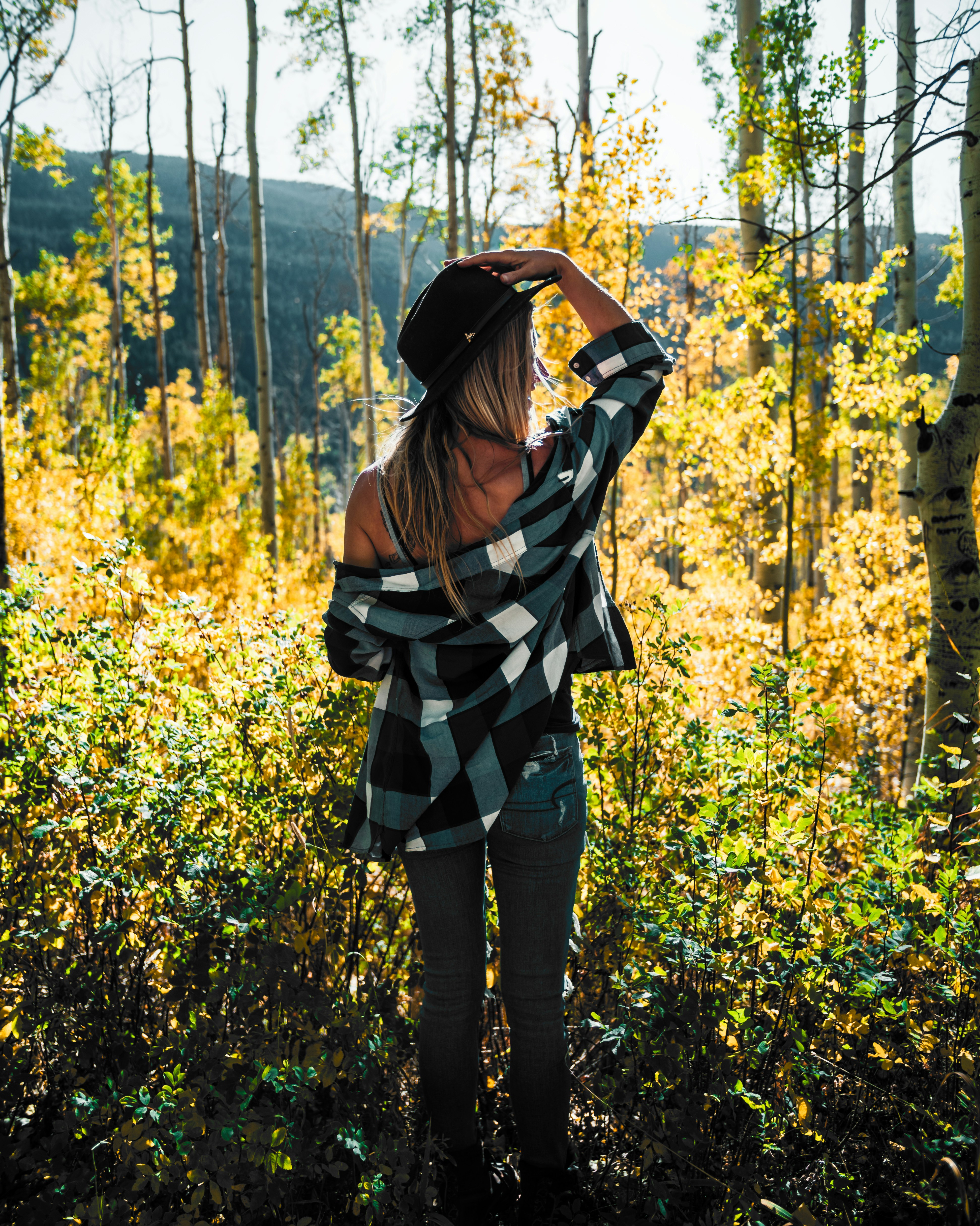 Woman wearing black and white top beside trees photo – Free Girl Image ...