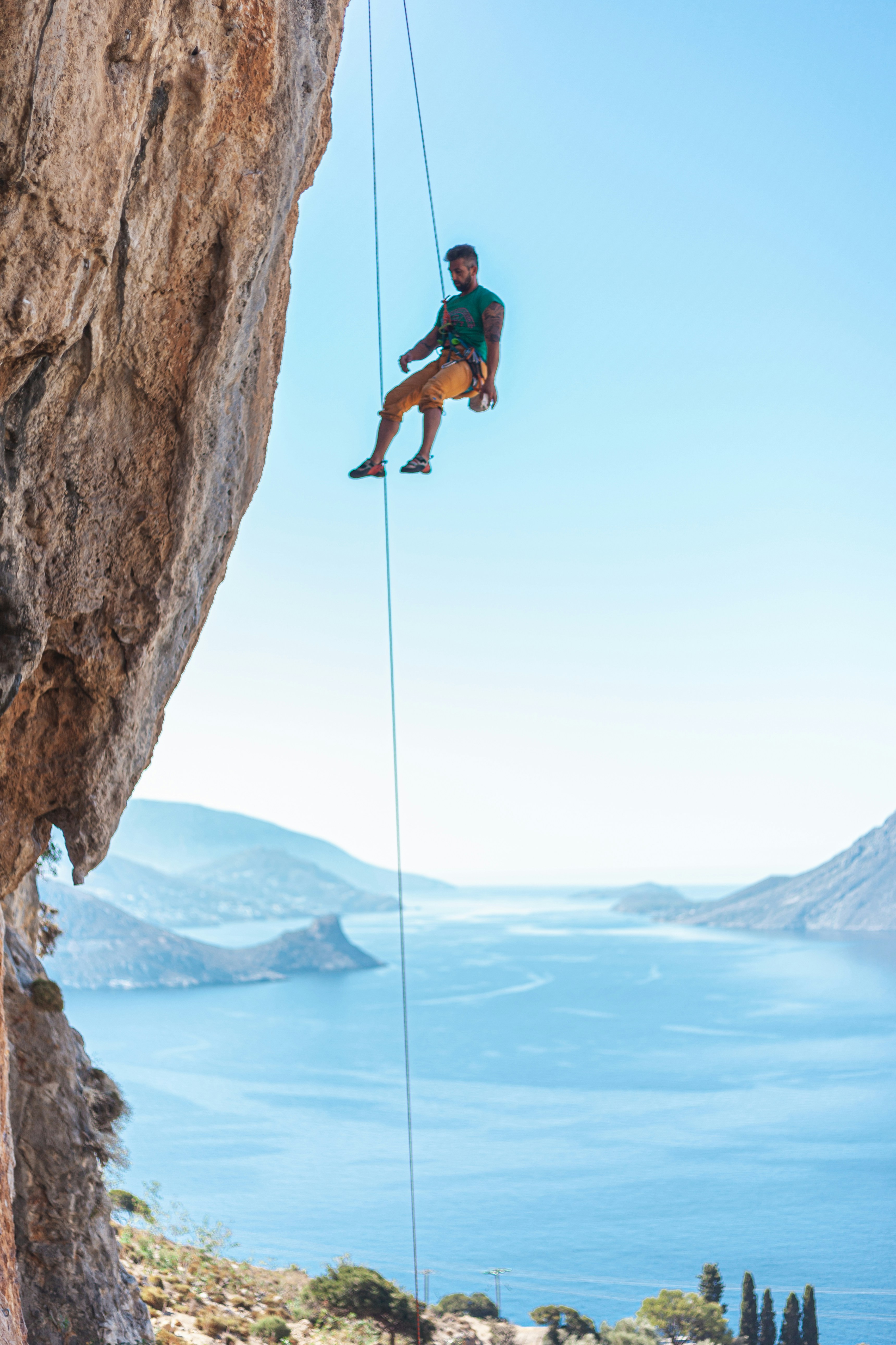 Man hanging on rope on cliff during daytime photo – Free Blue Image on ...