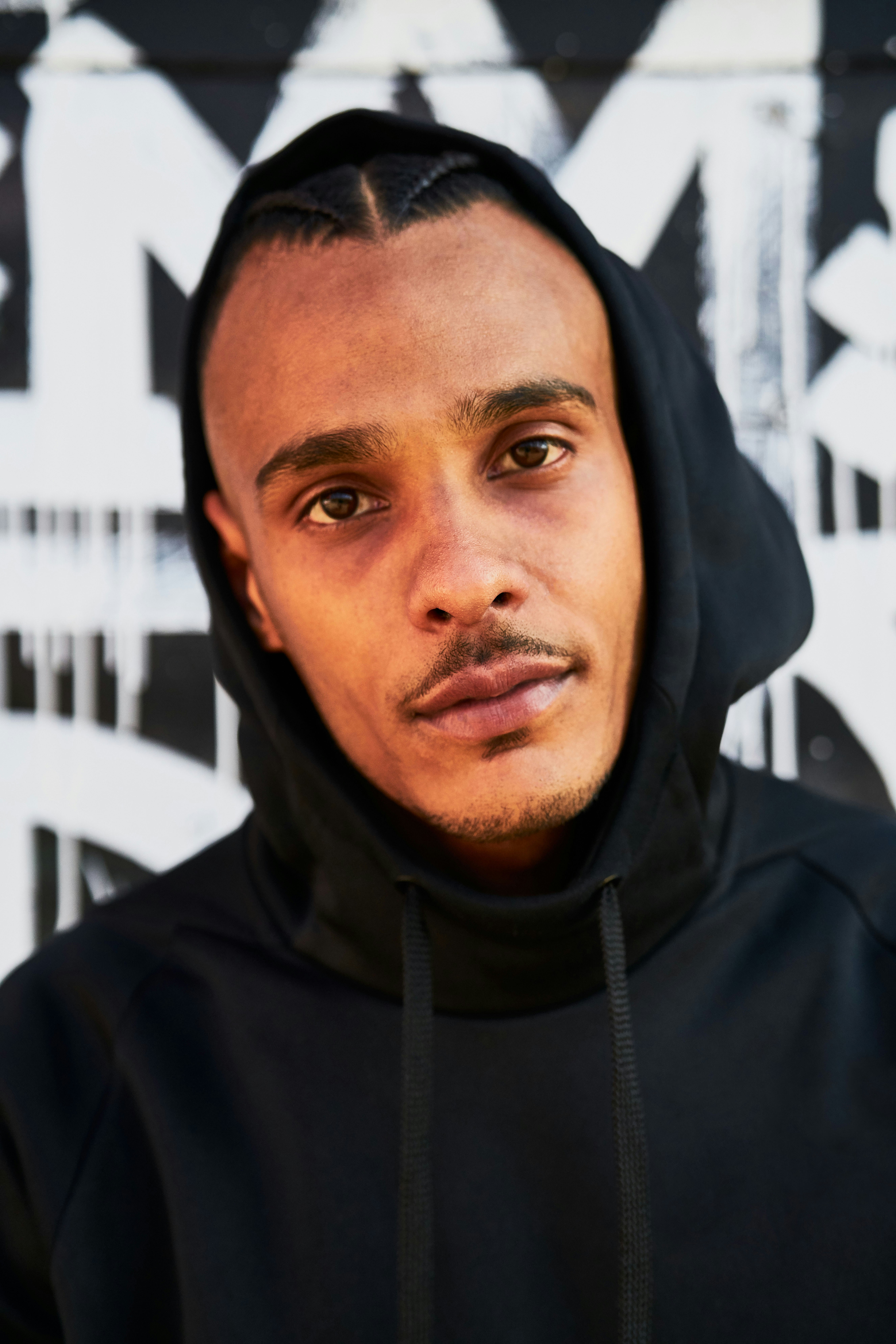 Direct Gaze Through Graffiti Lines: A Hoodie Portrait