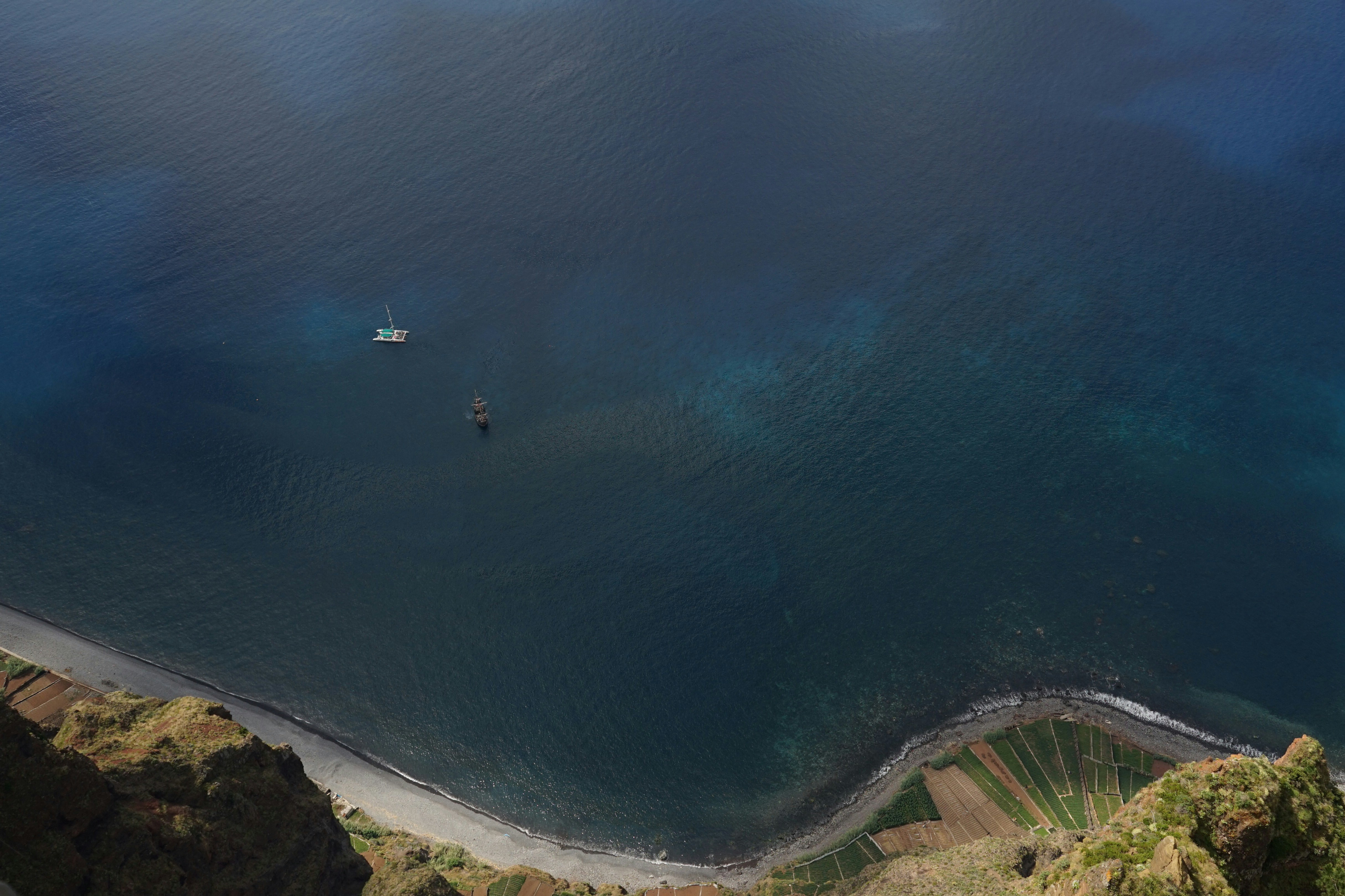 View of the ocean from the high pint in Madeira , with small drifting ships