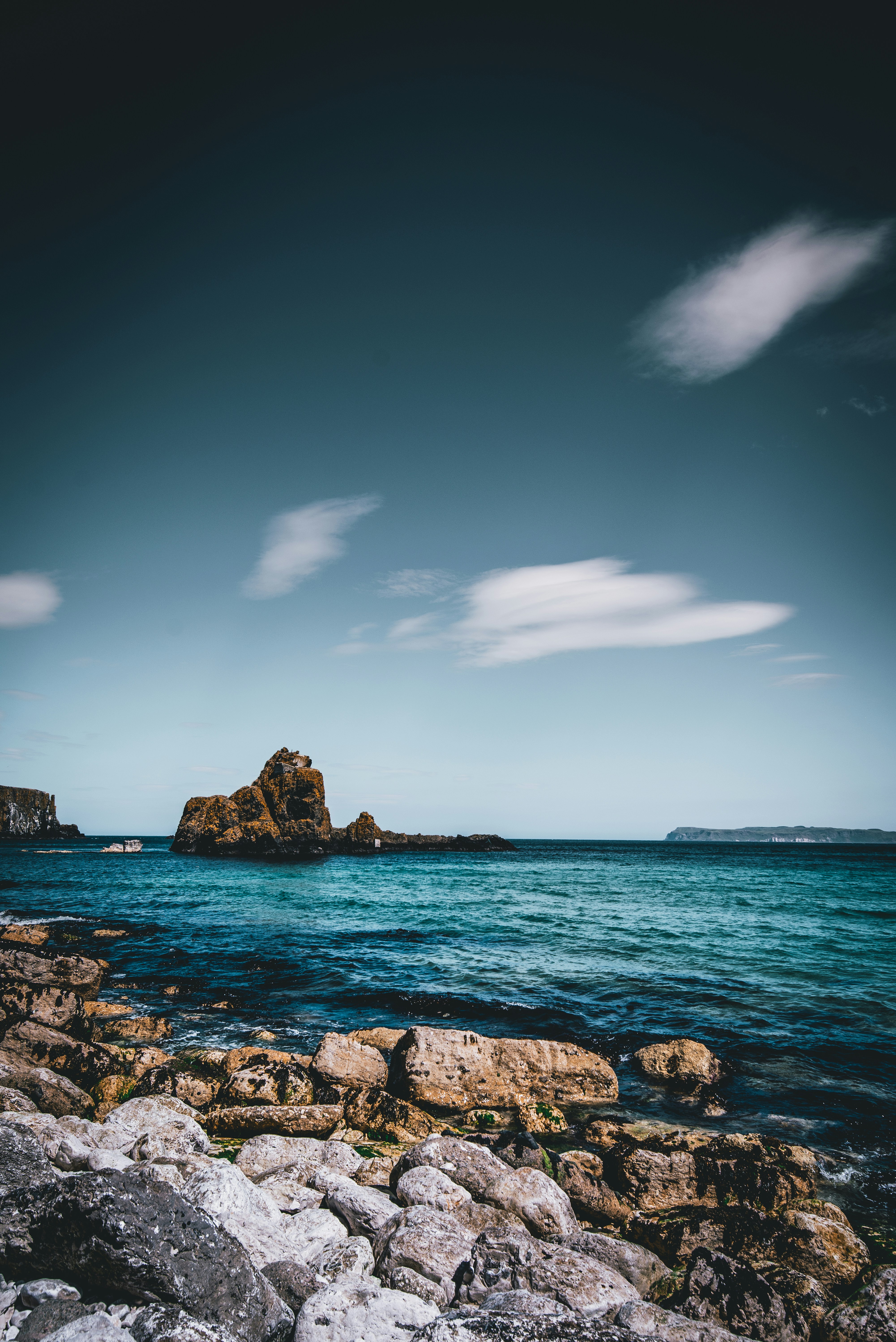 Gray stone beside body of water photo – Free Promontory Image on Unsplash
