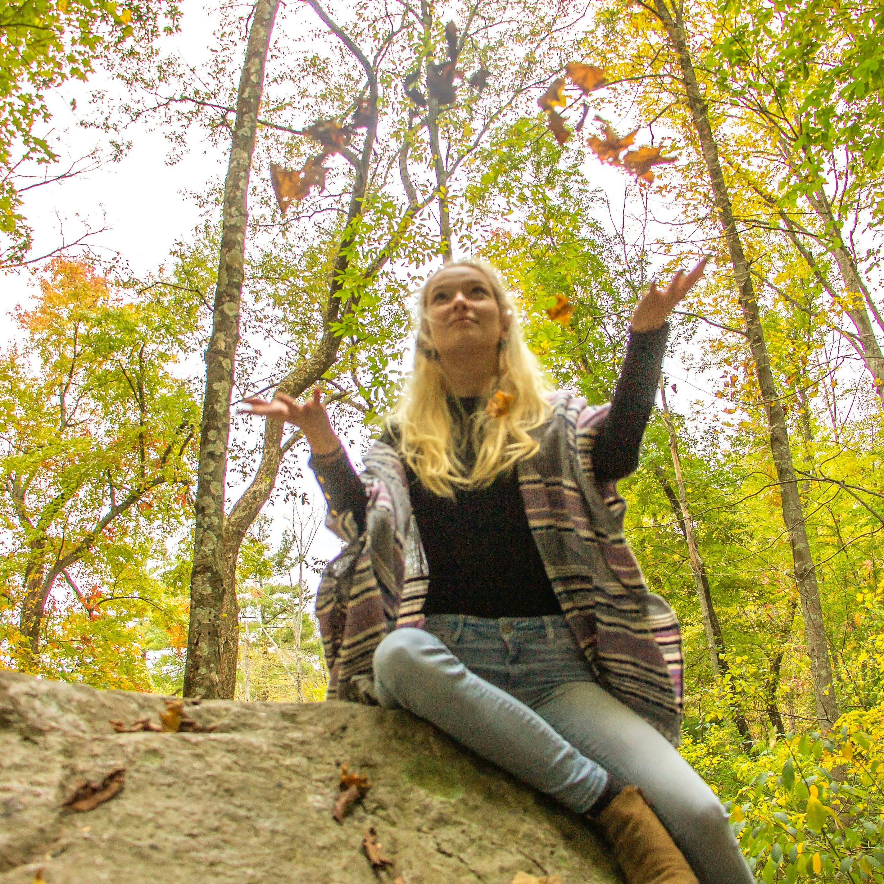 Forest Reverie: A Woman Connects with Falling Leaves