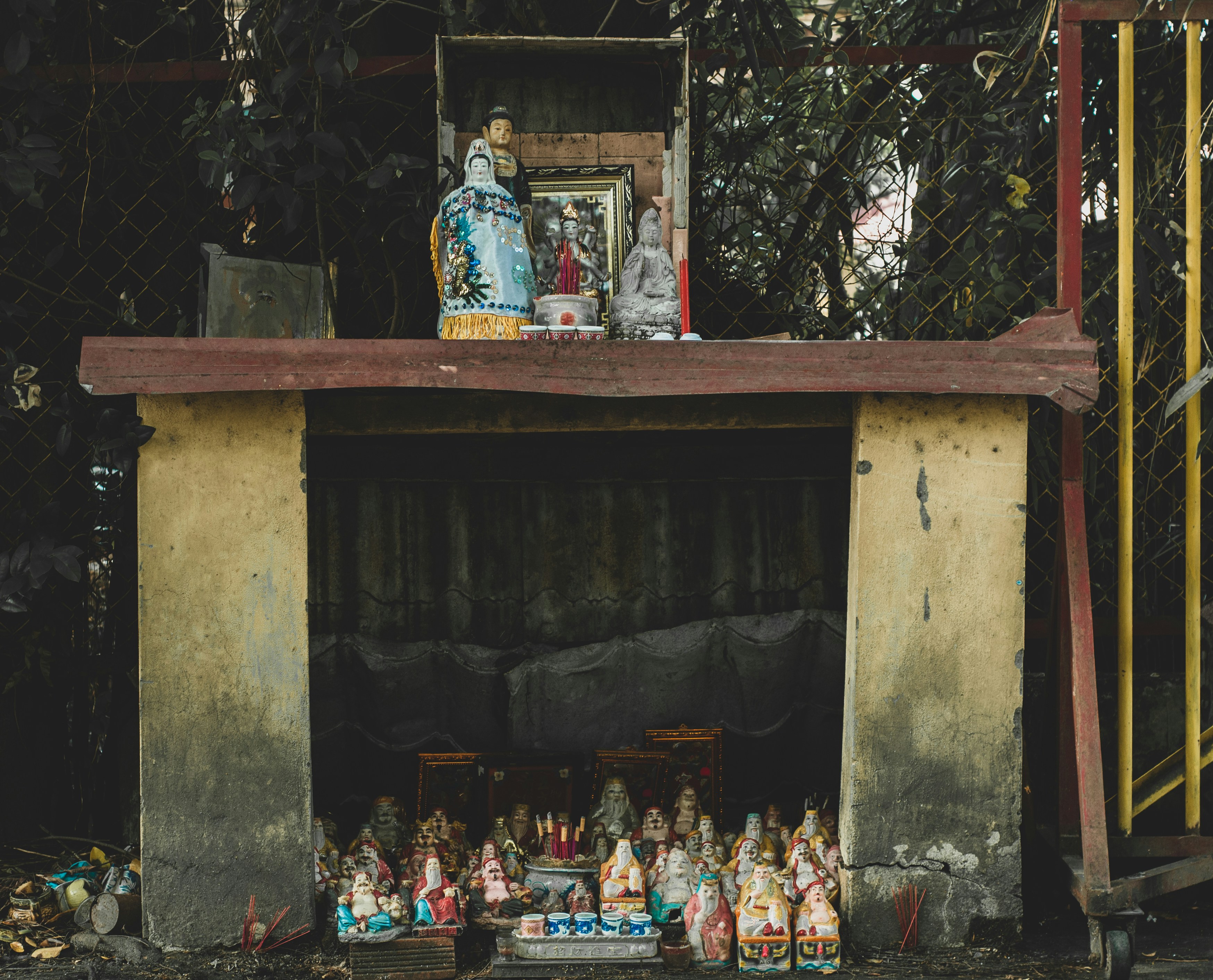 Sheltered Offerings: A Quiet Shrine with Rows of Tiny Figurines