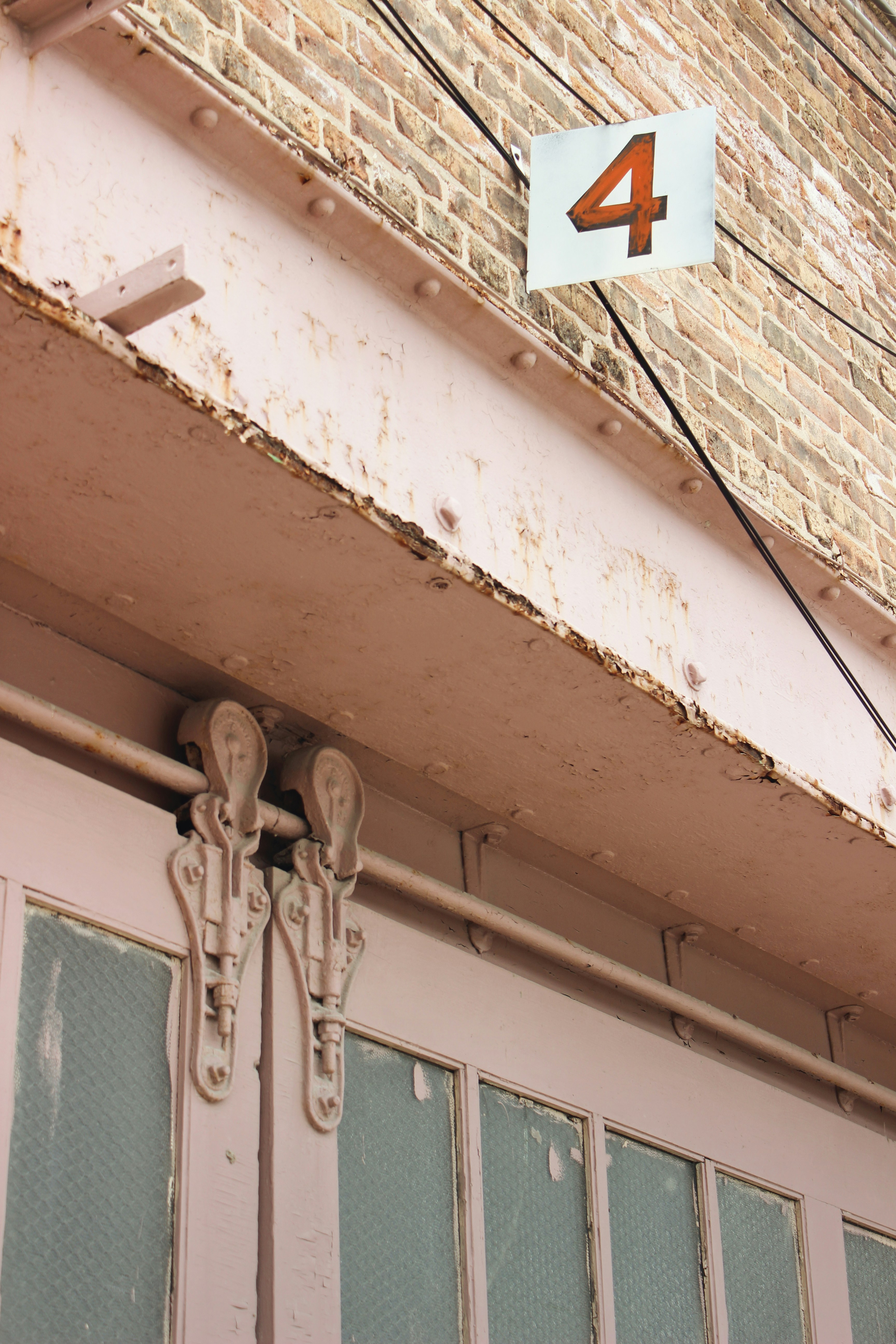 Number Four Above a Weathered Facade: An Industrial Doorway Scene