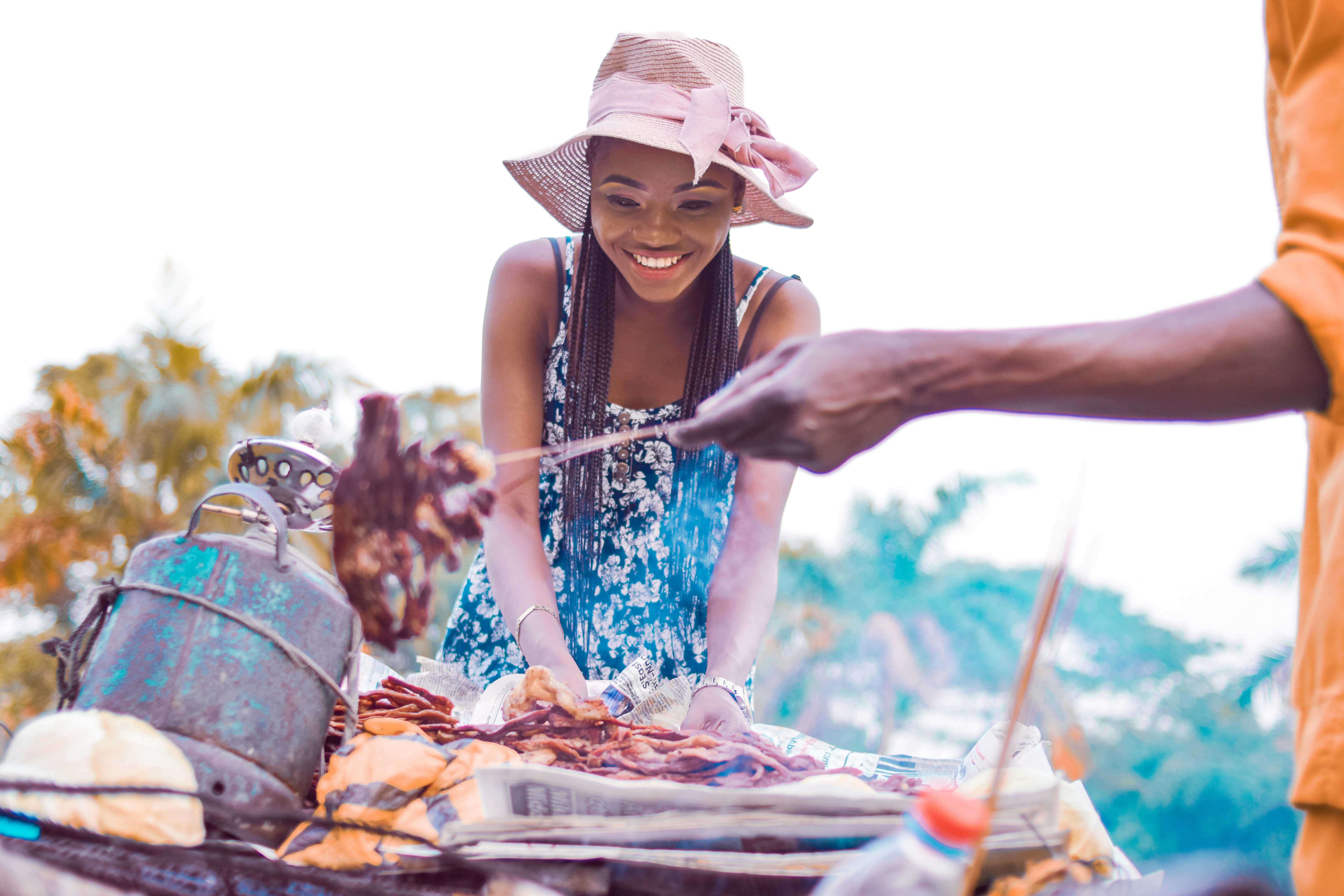 Sunlit Grillside Joy: A Smile Amid a Bustling Beachside BBQ