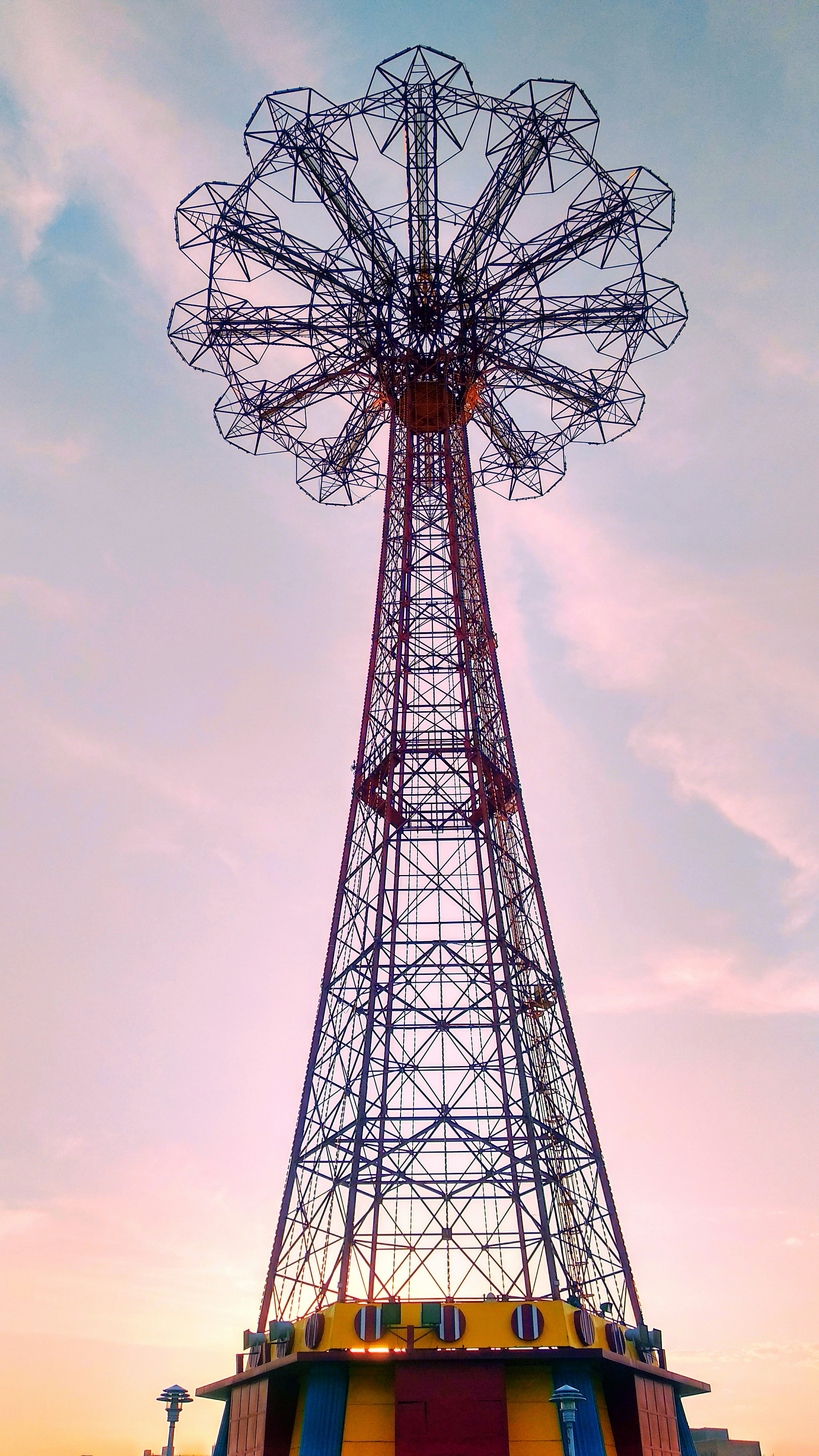 Historic amusement park ride silhouette against a pastel sky at dusk.