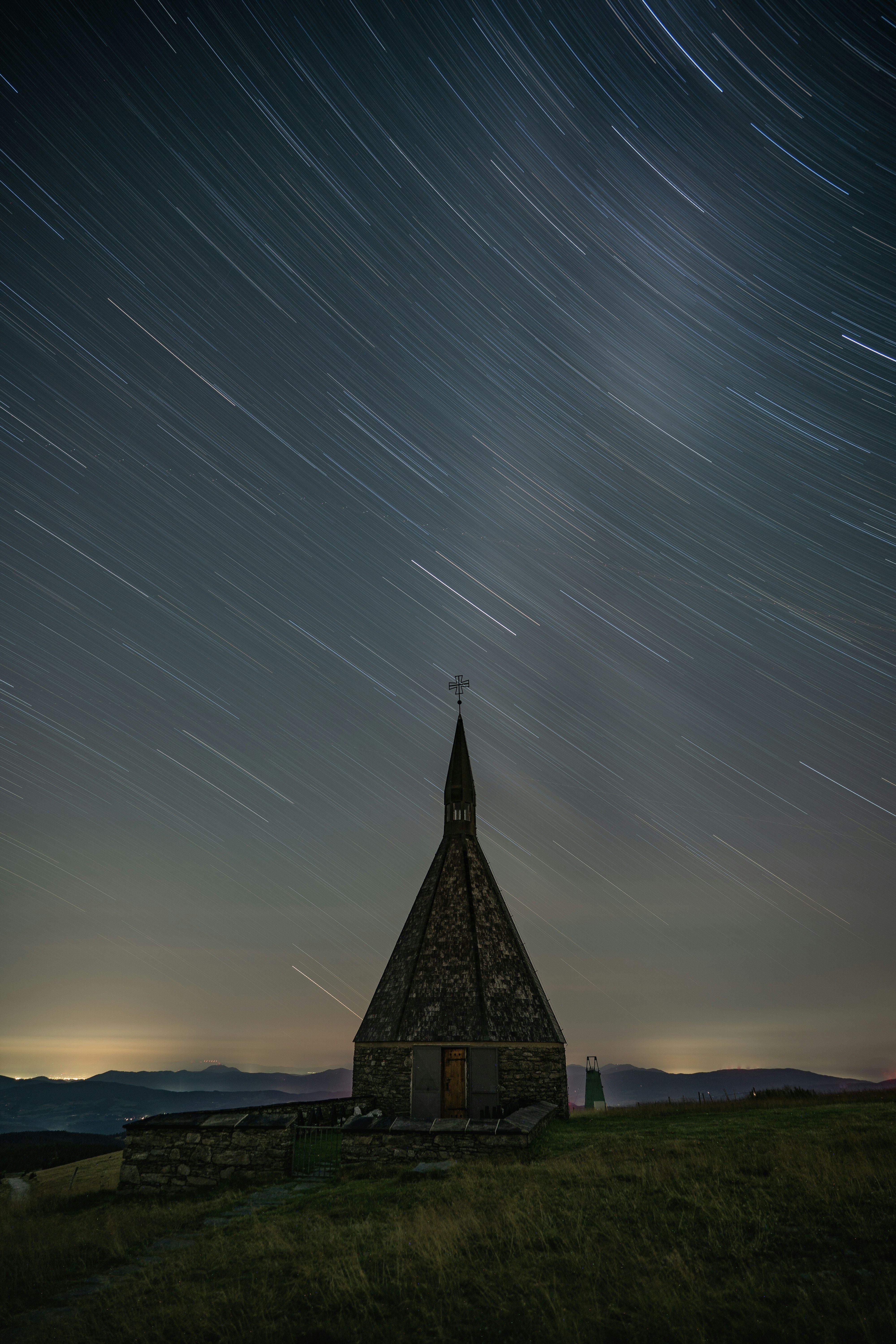 Star-Threaded Chapel: A Hilltop Shrine Beneath Circling Star Trails