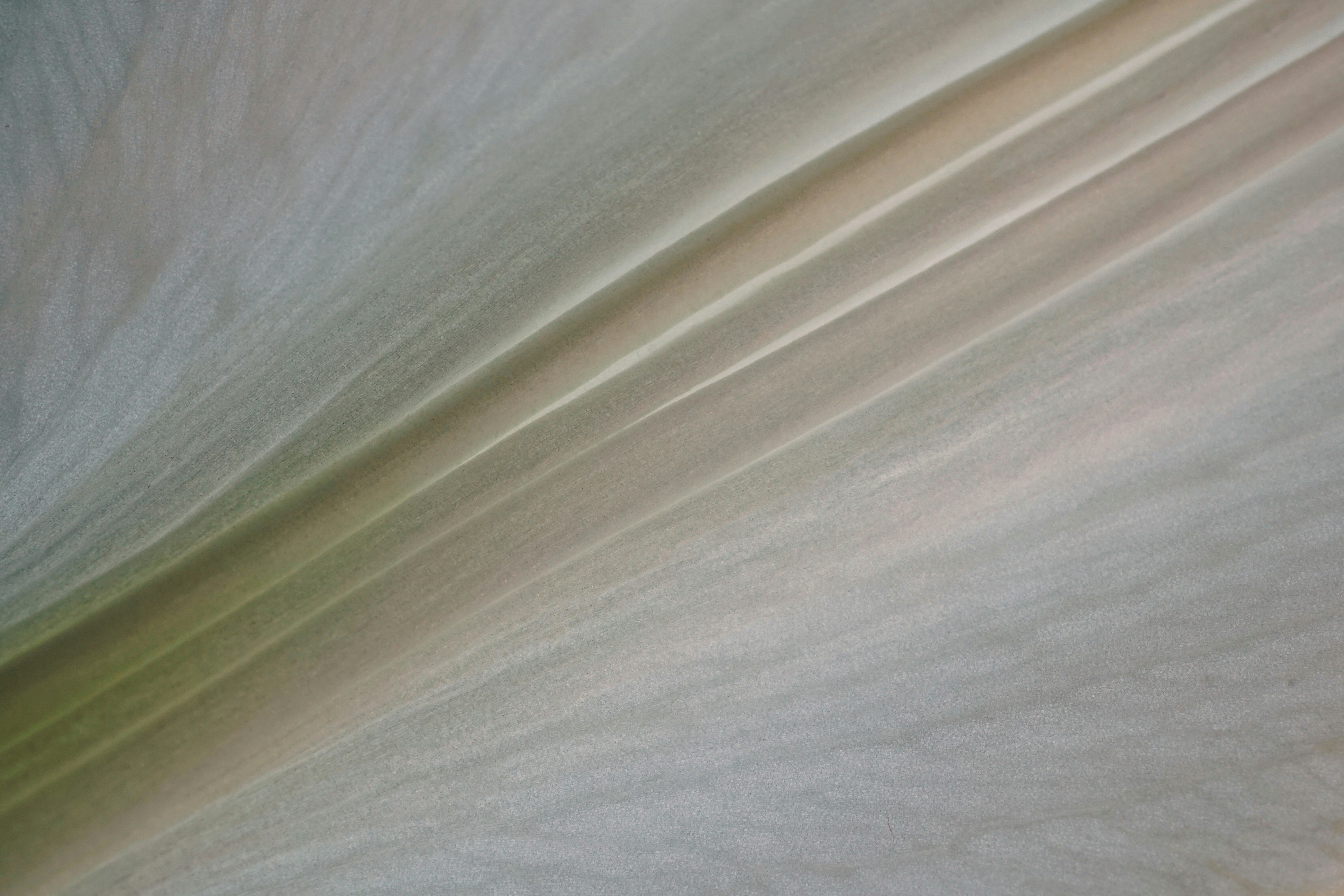 Muted Arc of Light Across a Soft-textured Surface