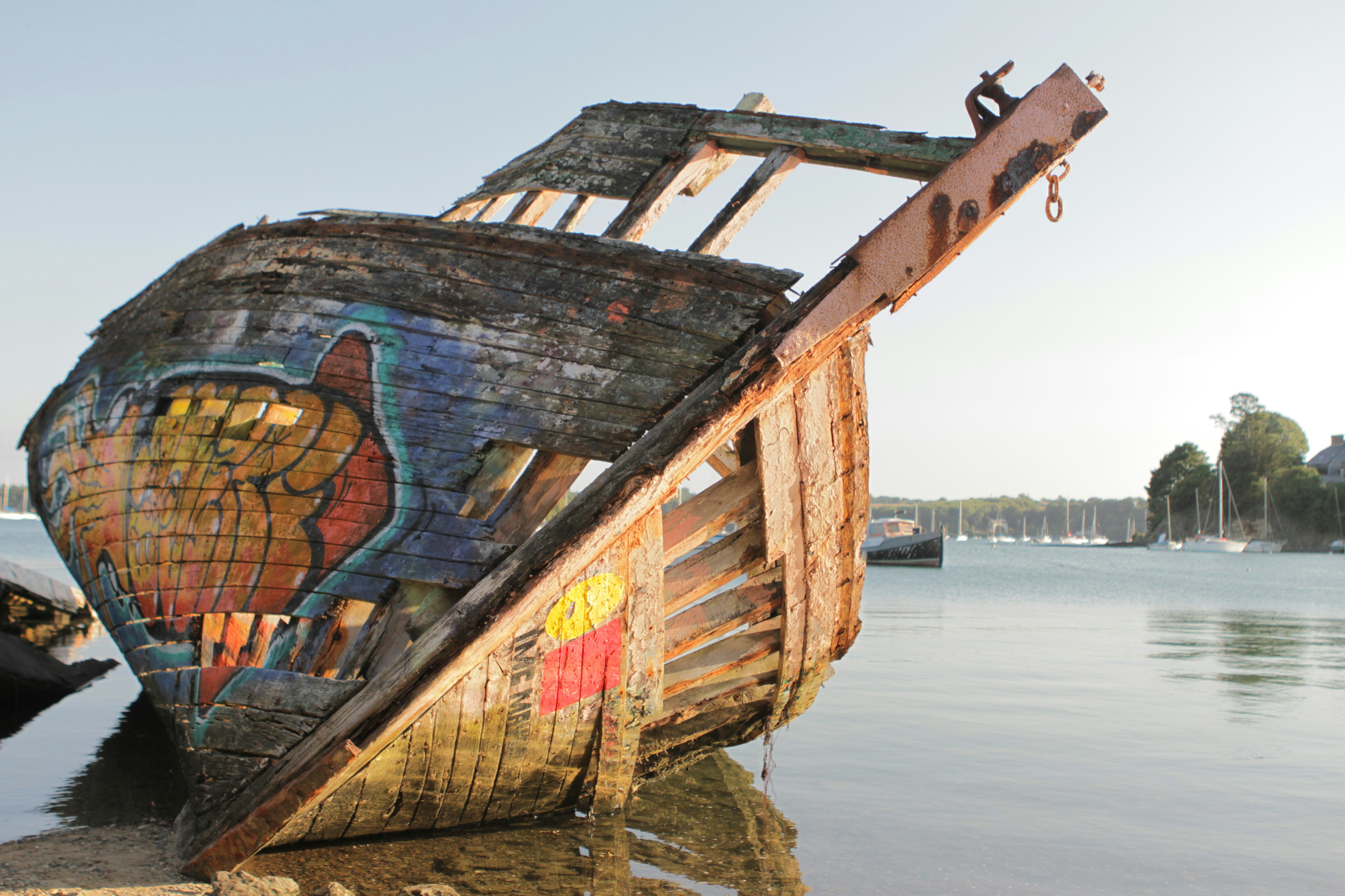 Graffiti-Decorated Shipwreck Leaning into the Waterline