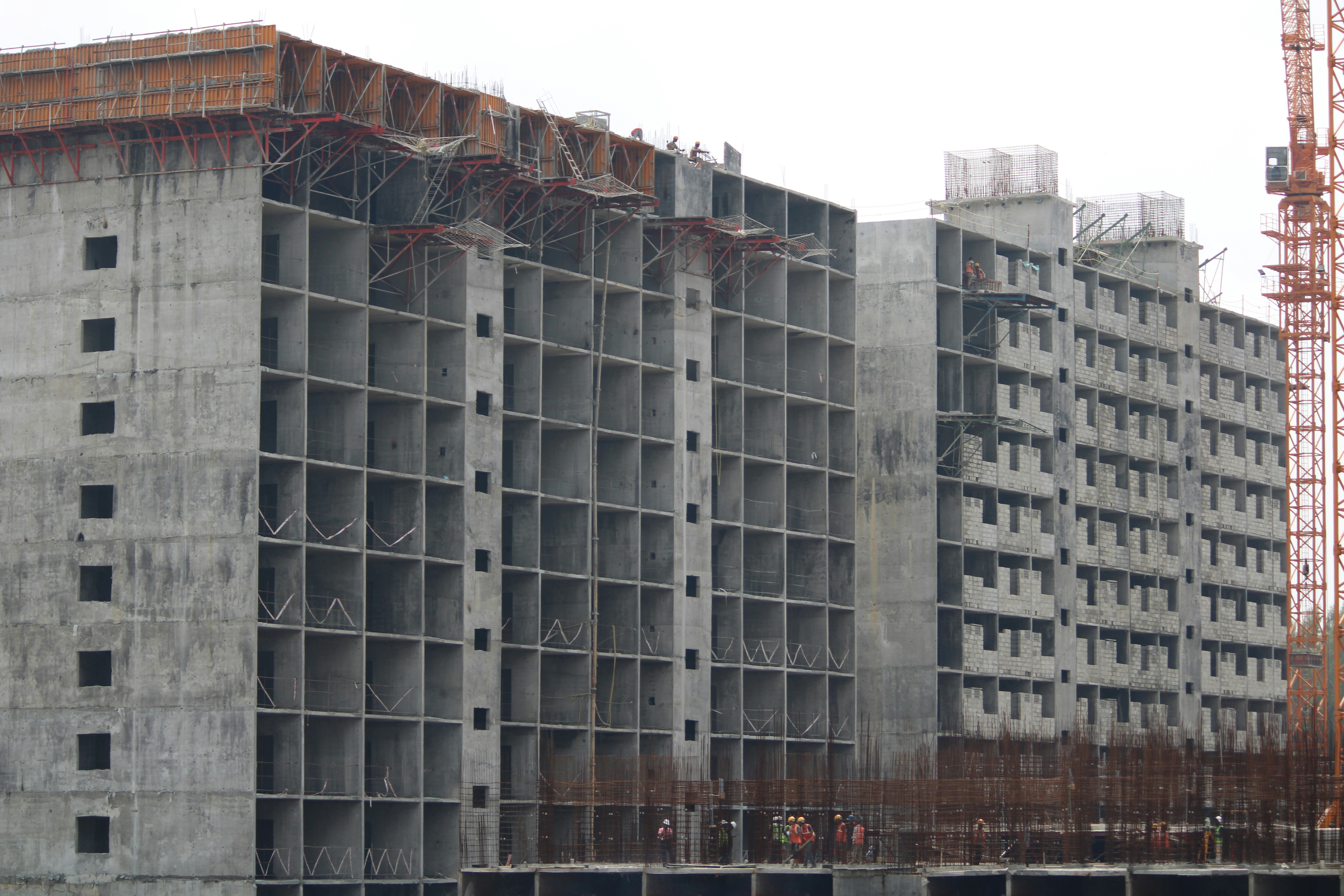 Concrete Crescendo: A Tower Under Construction Looms Over Steel Skeletons