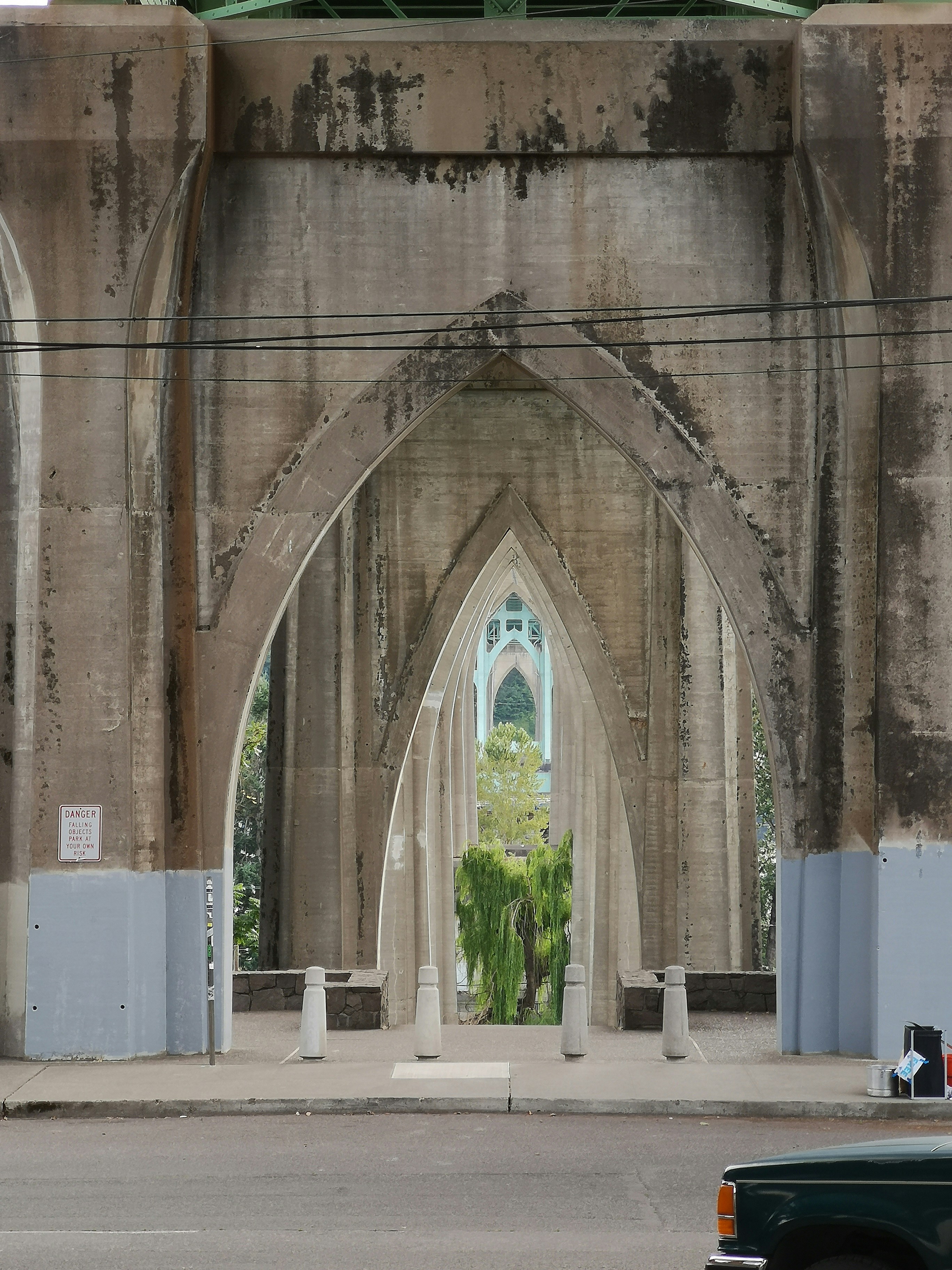 Overpass Cathedral: Receding Arches Framing a Quiet Garden