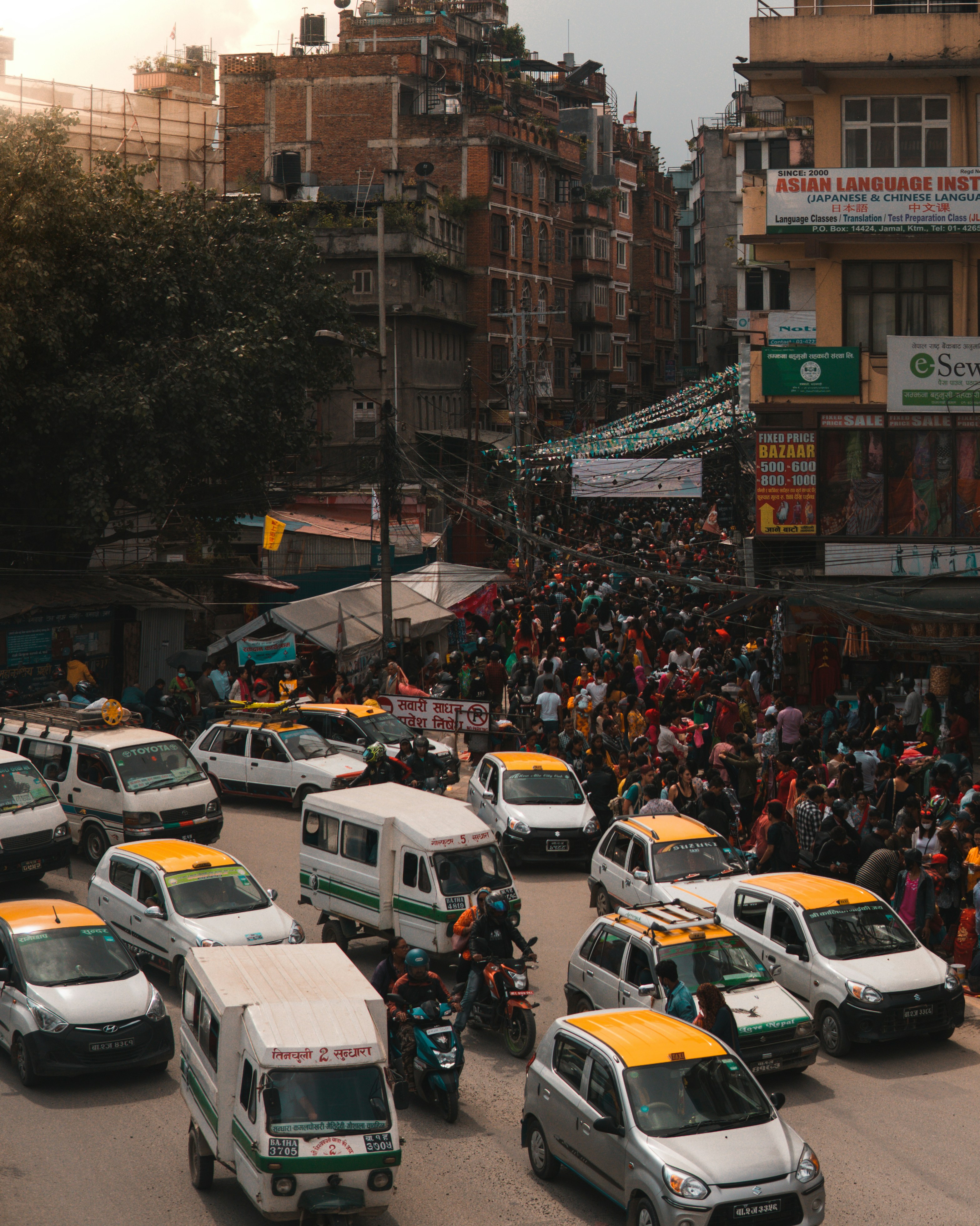 Dusk Confluence on a Bustling Bazaar: Yellow-Topped Taxis and the Crowd