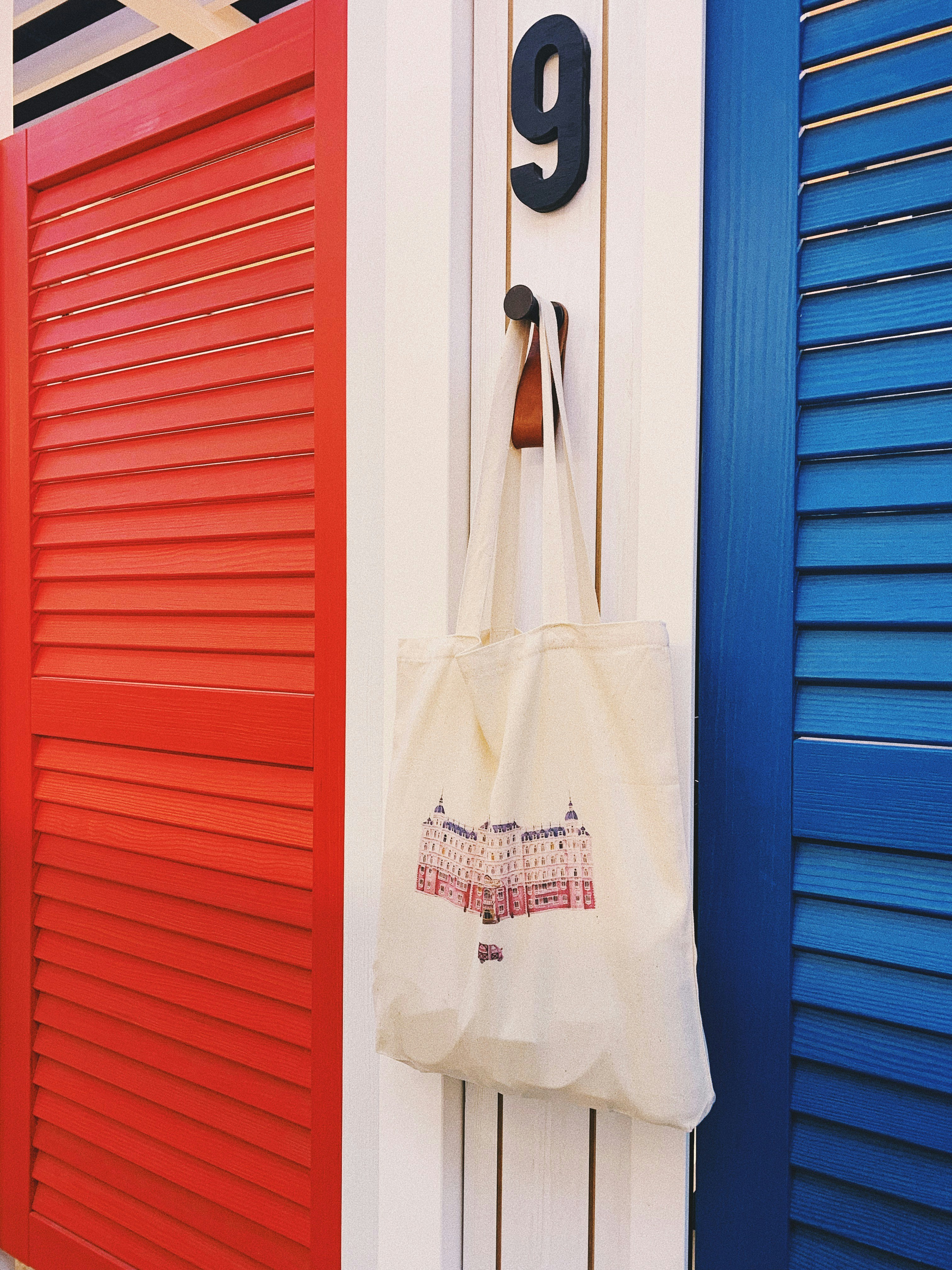 White tote bag hanging beside red door photo – Free Miami beach Image ...