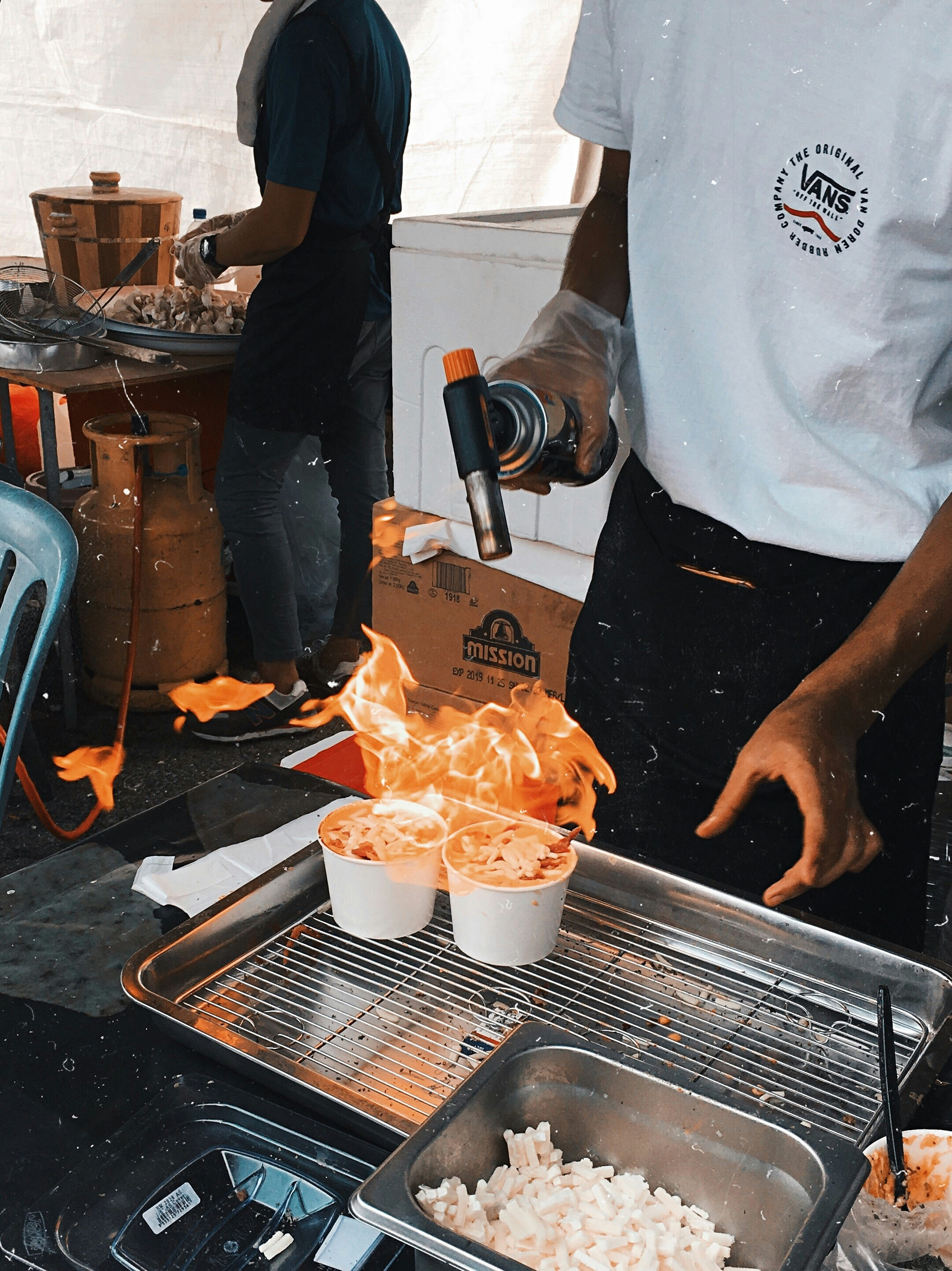 Flames and Frost: Street Kitchen Fire in a White-Tee Cart Scene