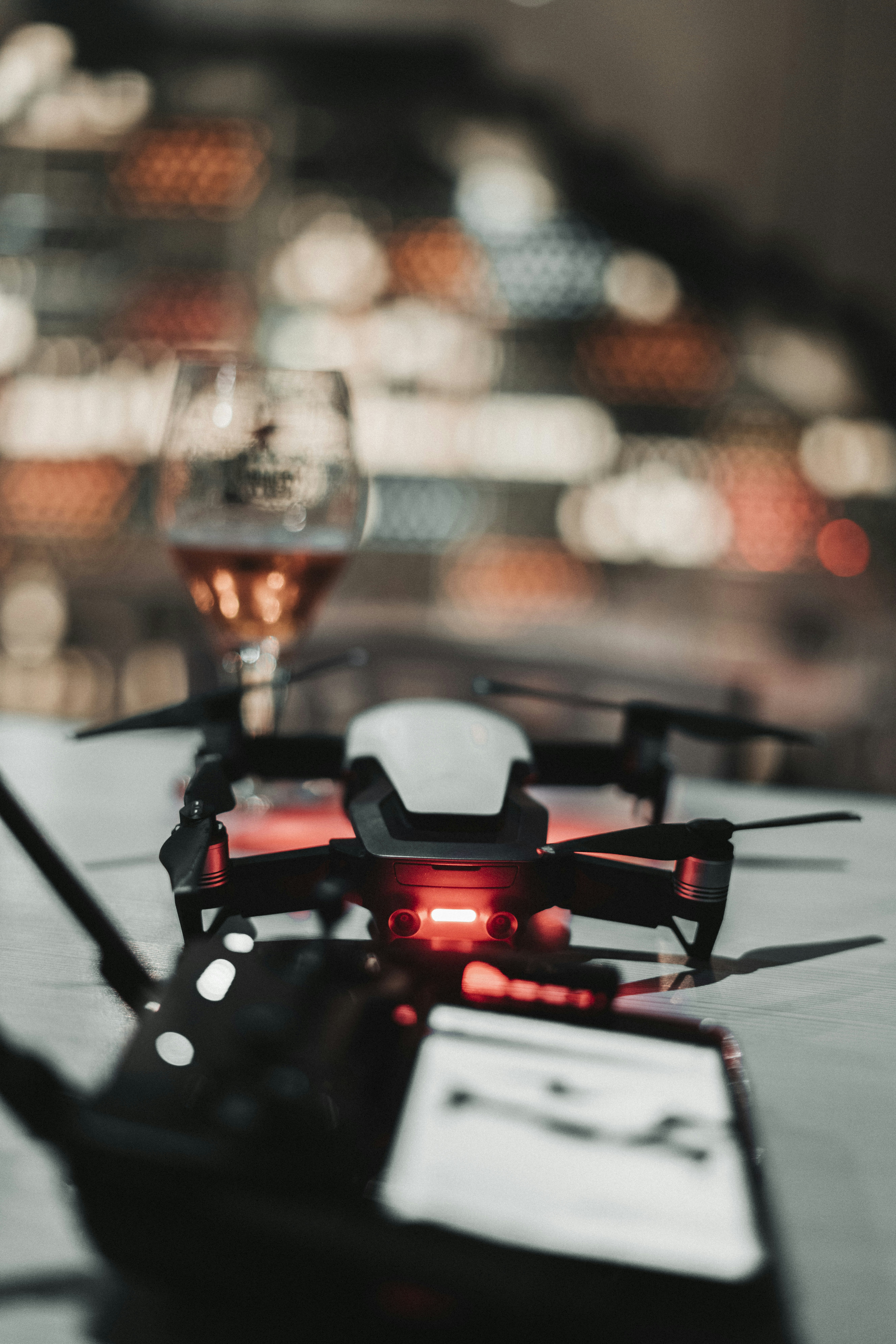 Red-LED Quadrotor at Rest on a Table as Velvet Bokeh Softens the Evening