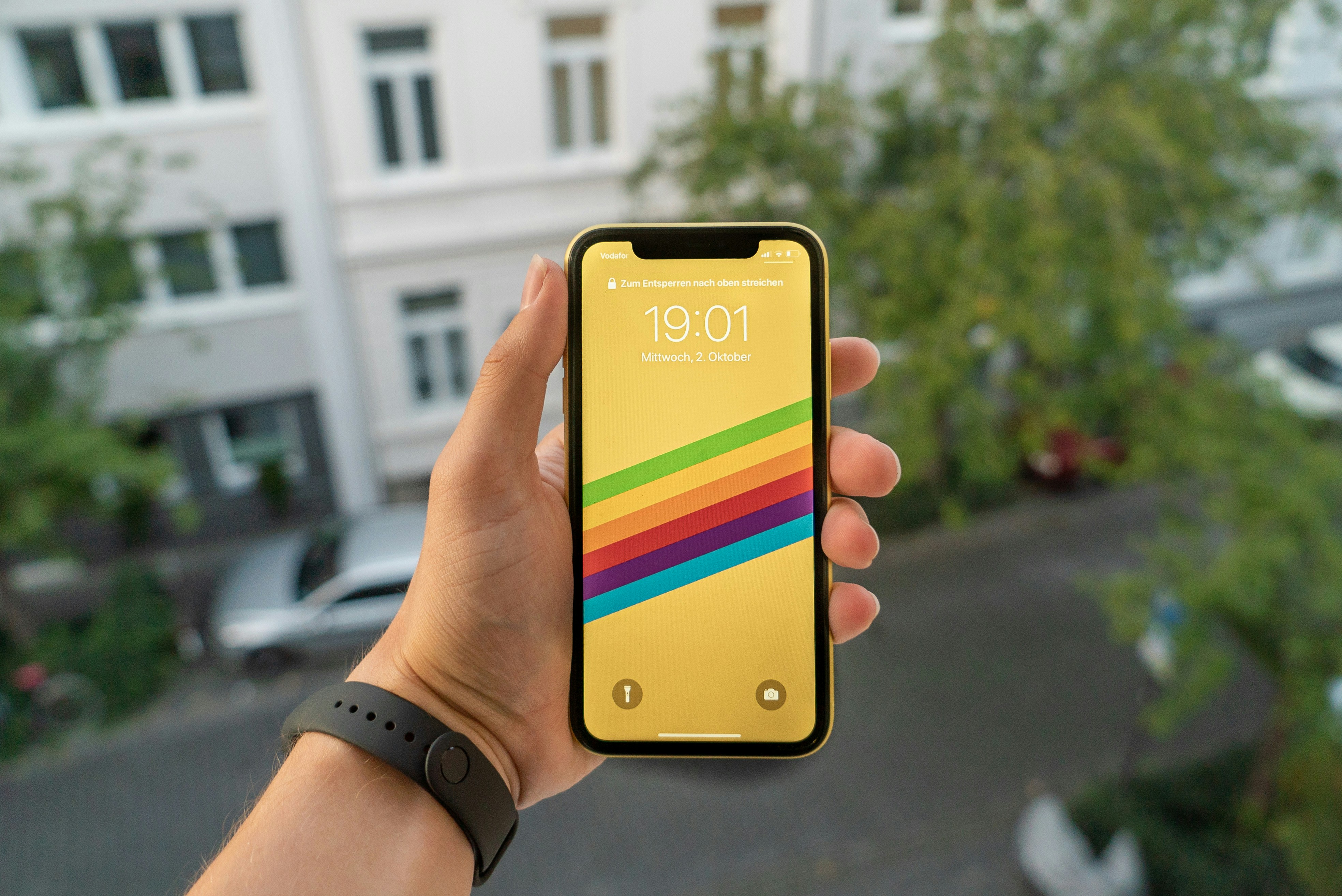 Diagonals of Color: A Hand-Held Phone in a Quiet Courtyard
