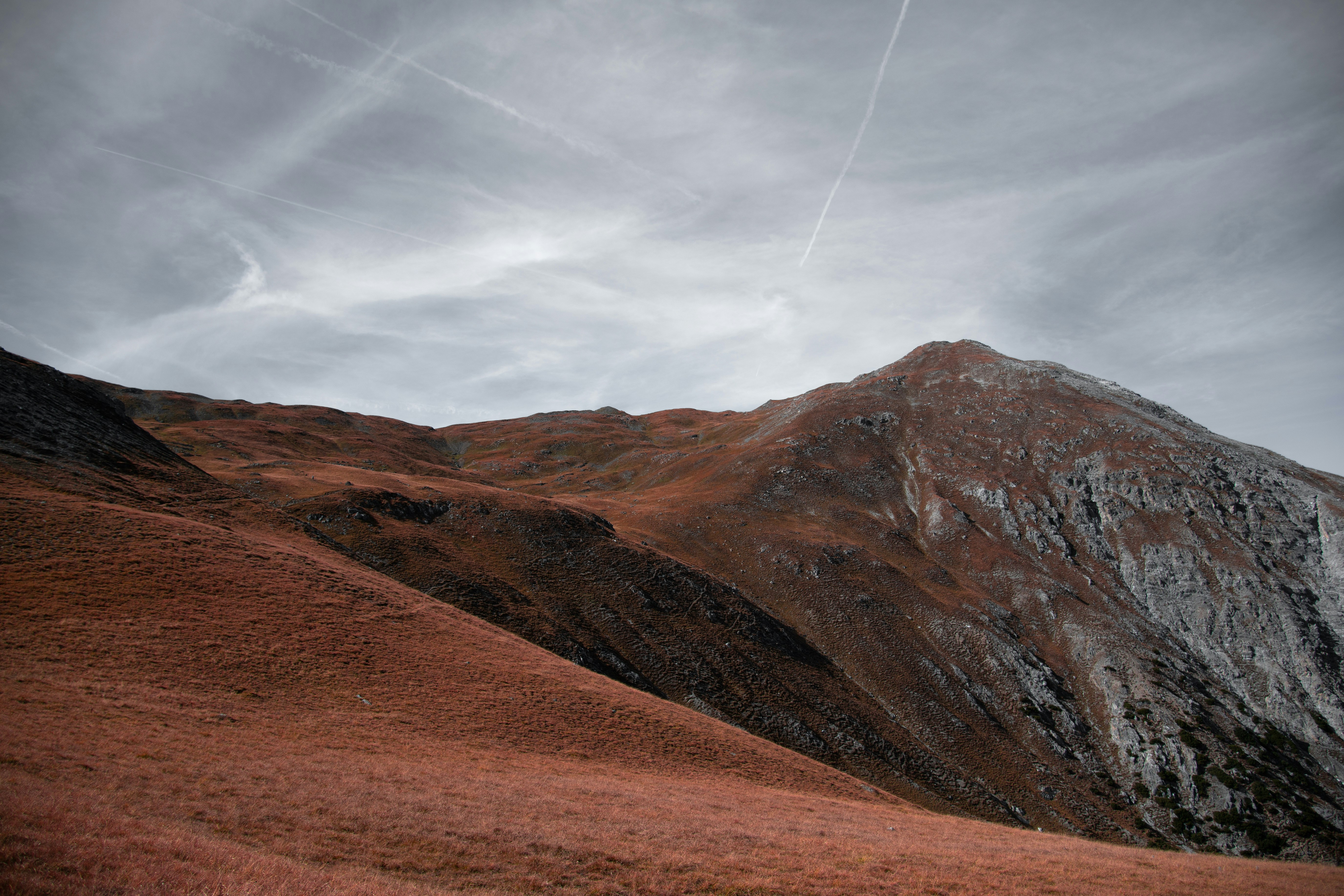 Ember Ridge under a Contrail Sky