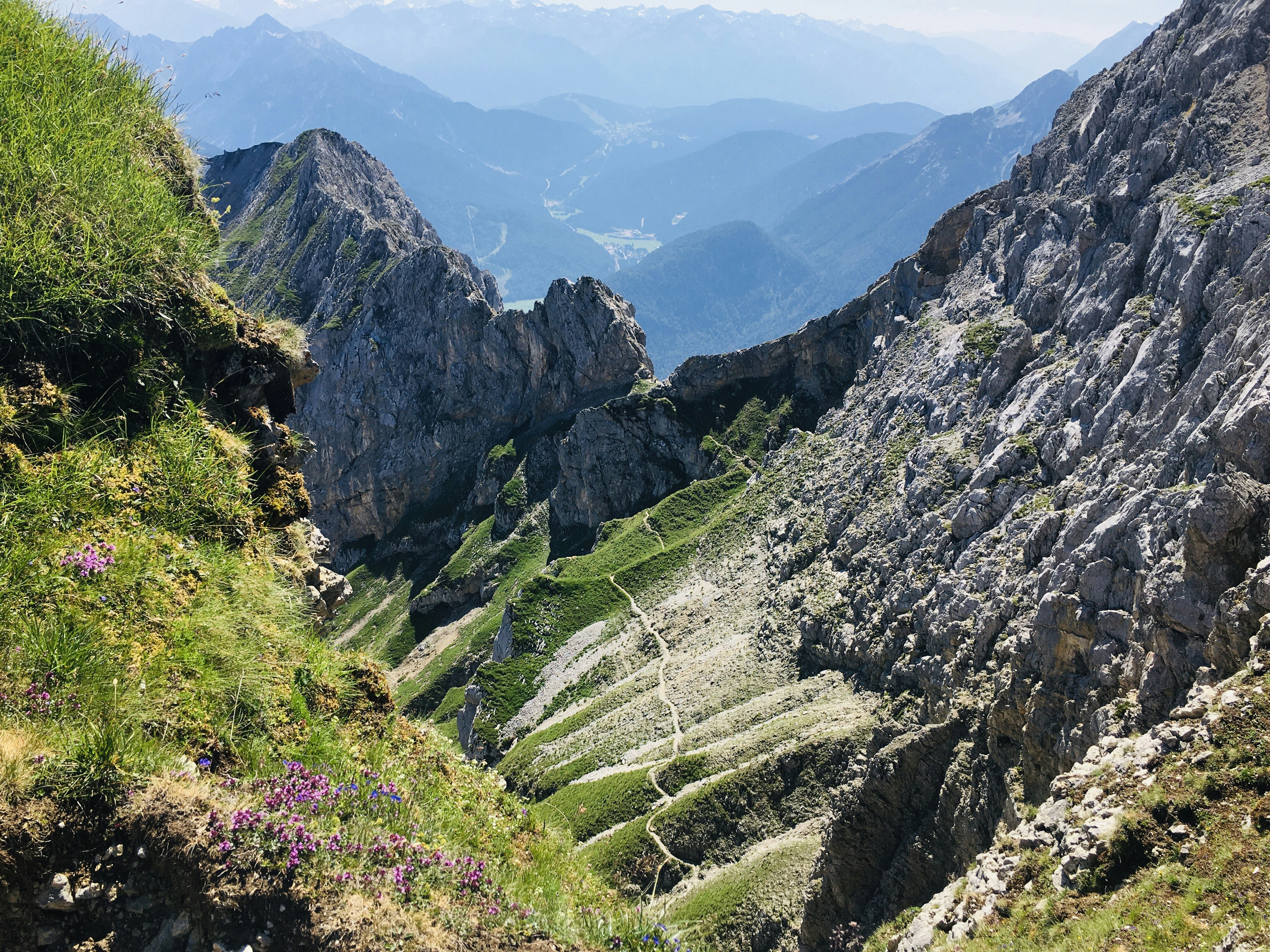aerial photography of green field viewing mountain during daytime