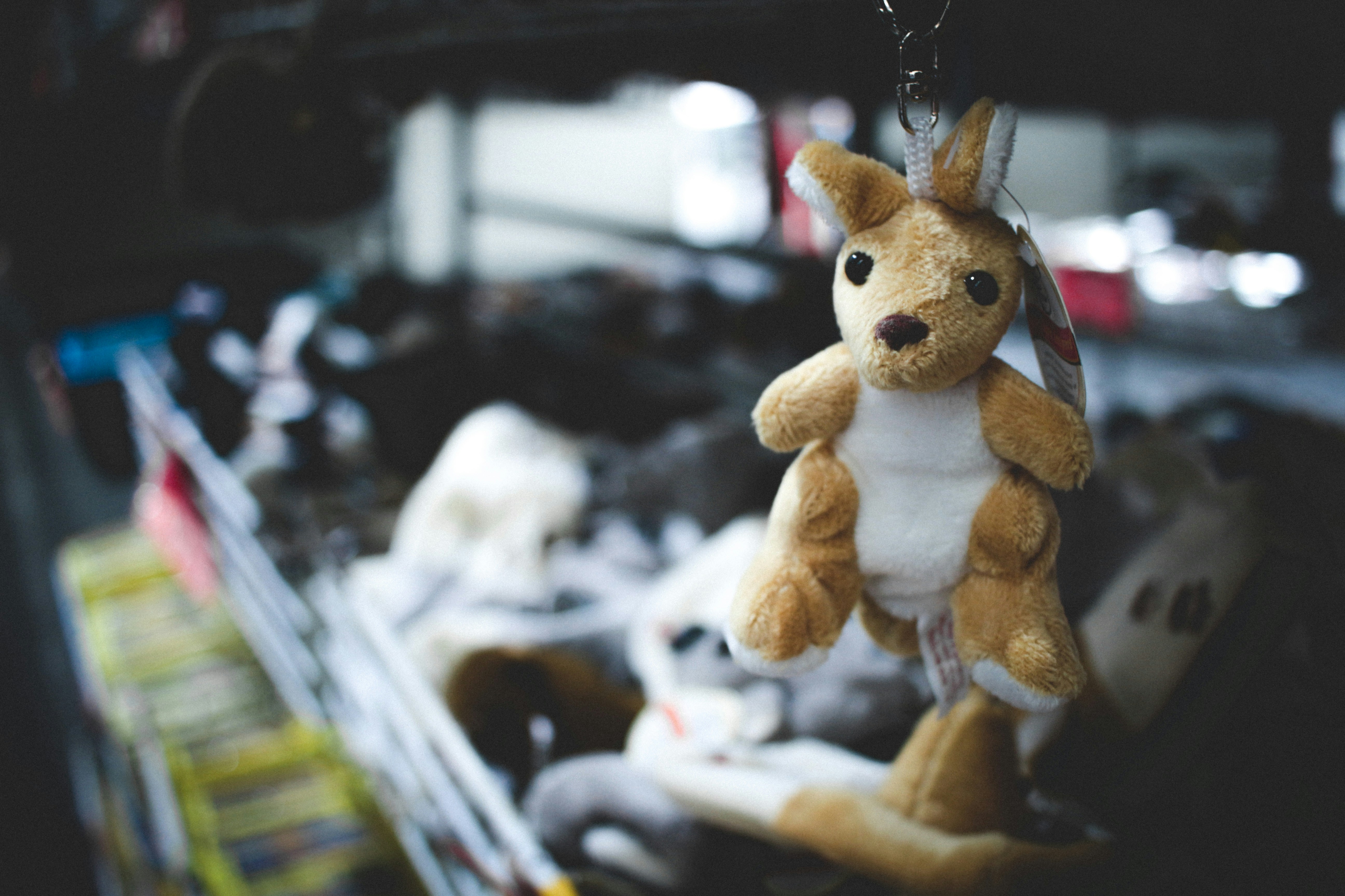 Suspended Plush Reindeer in a Dim, Cluttered Workshop