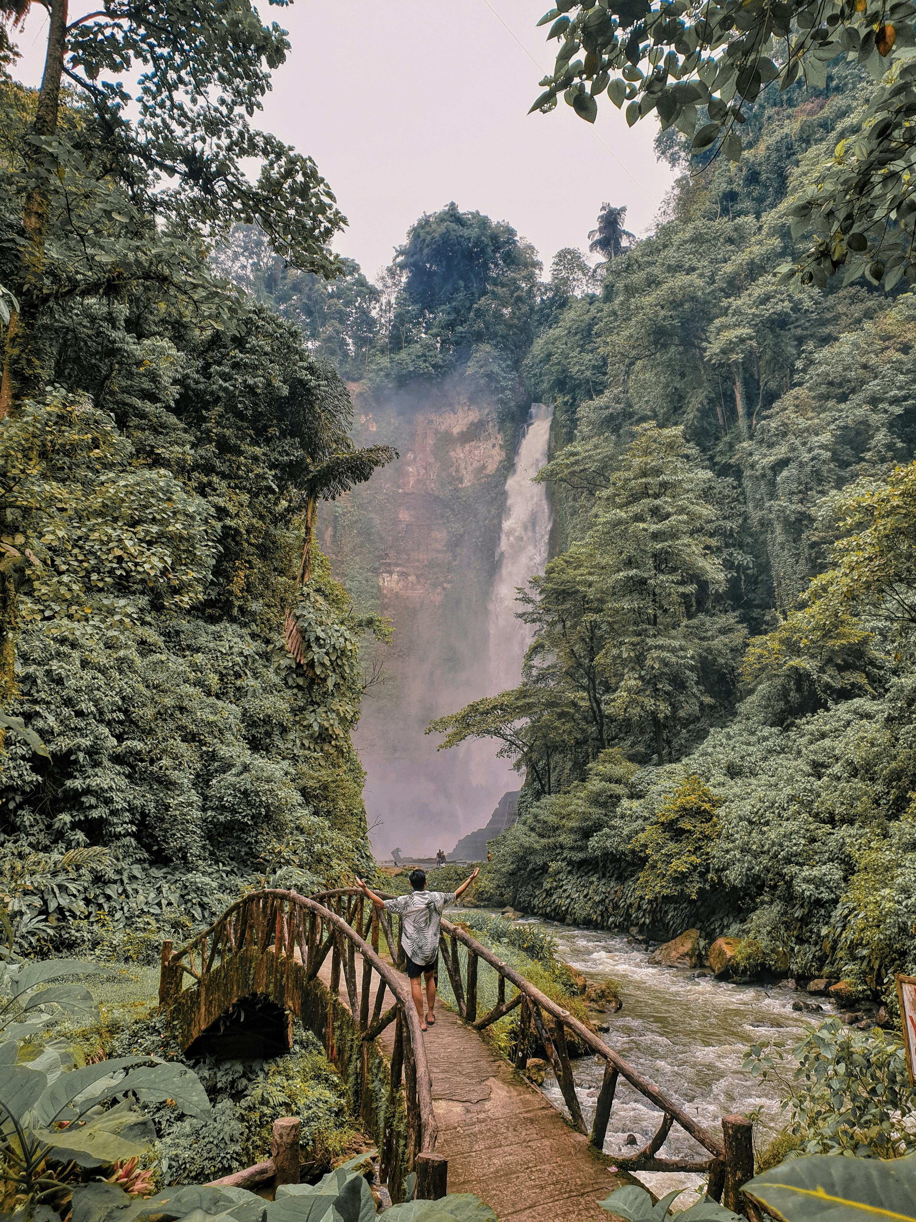 Person walking along a bridge over a river photo – Free Portrait Image ...