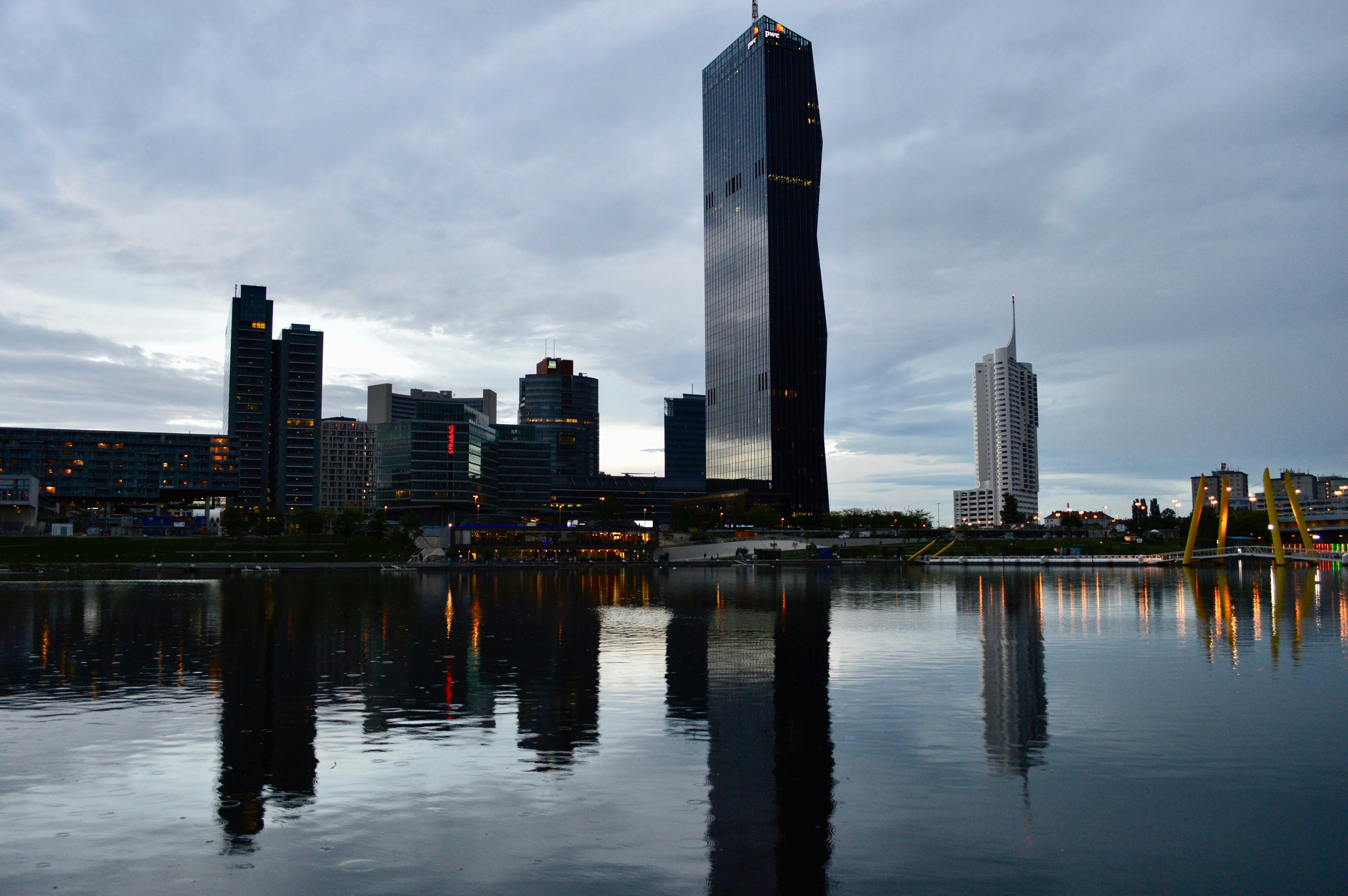 Architectural photography of city buildings near body of water photo ...