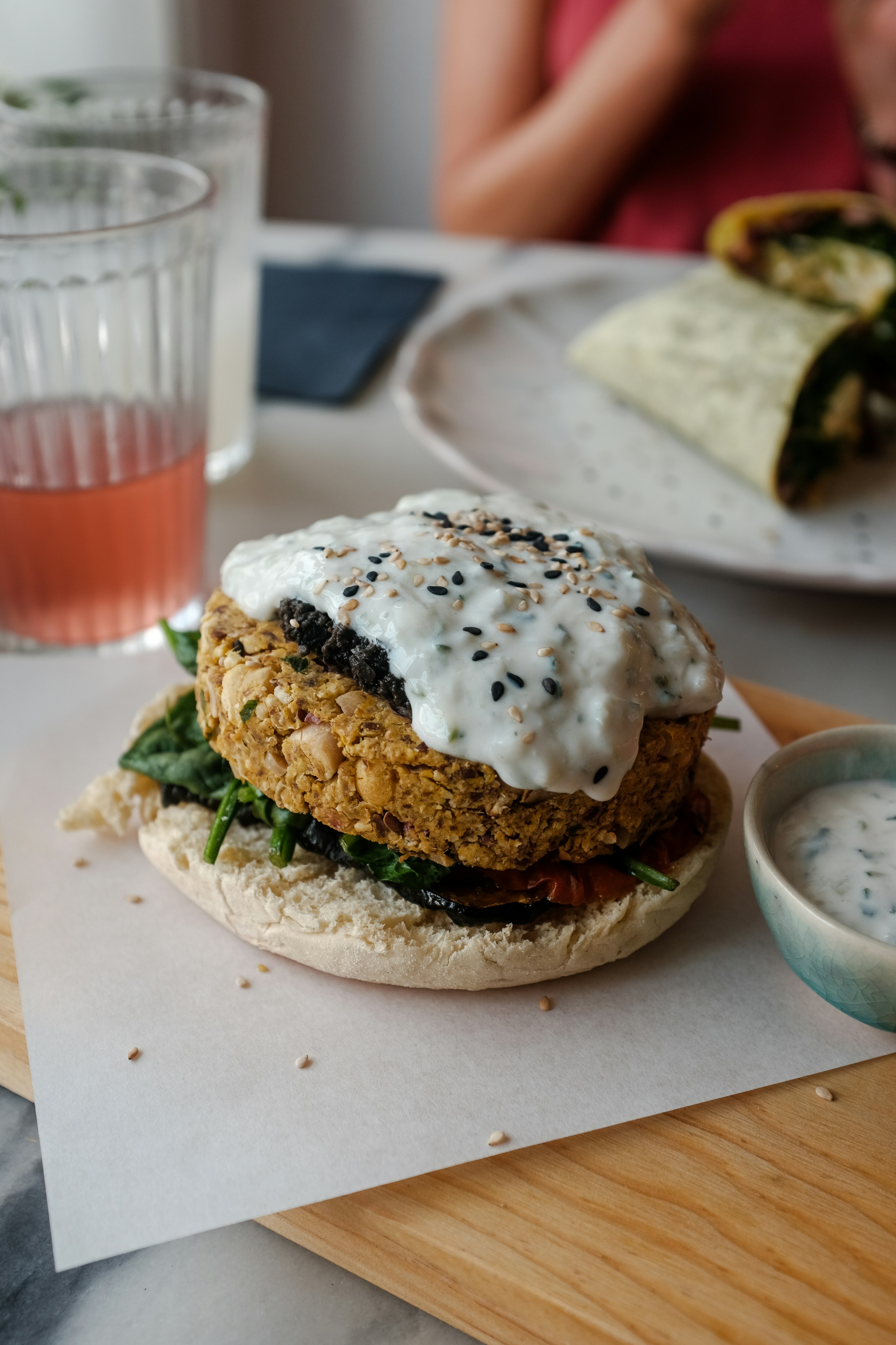Sesame-Crowned Crunch Burger on a Sunlit Wooden Platter