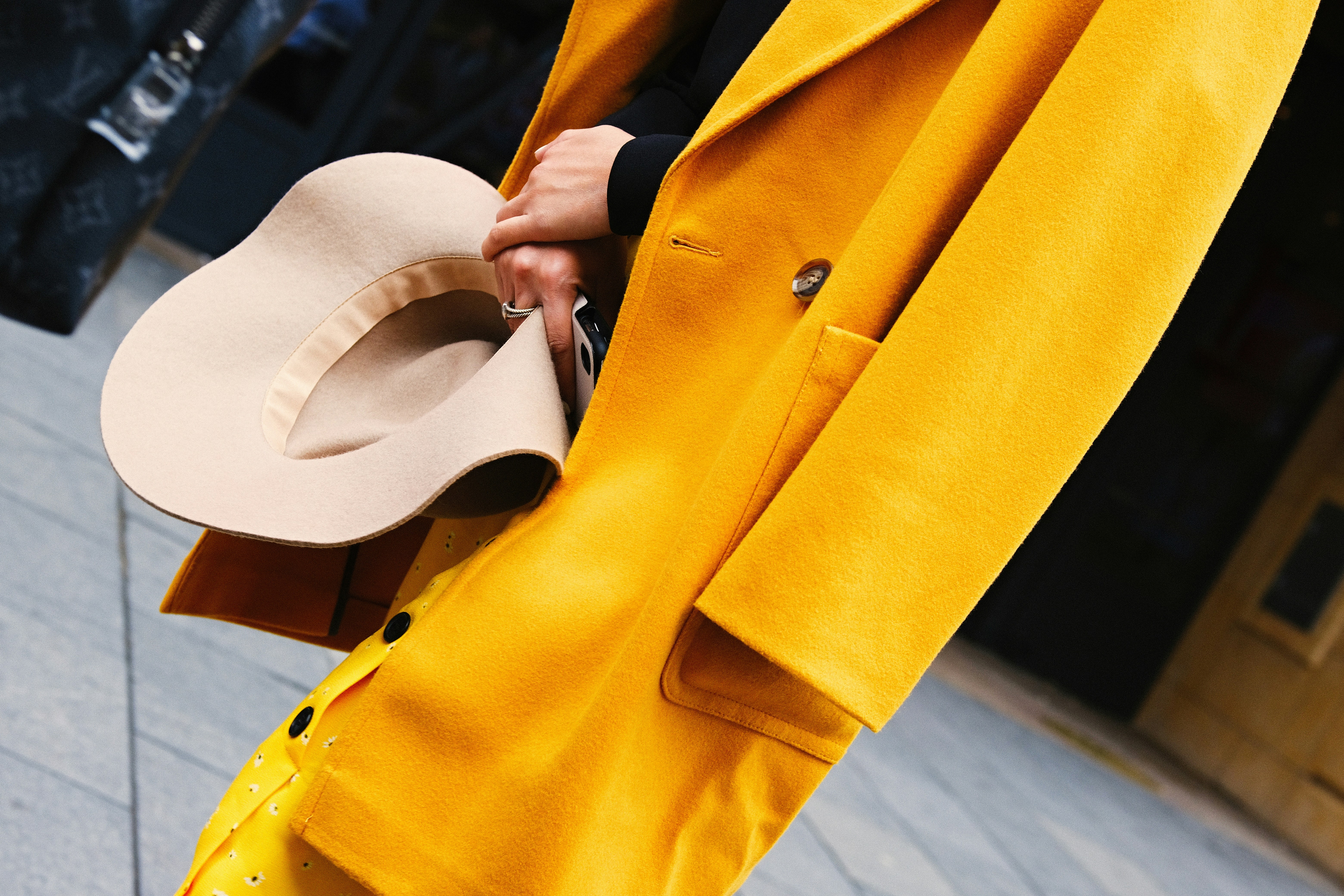 Amber Overcoat, Beige Fedora: A Street Moment in Color and Grip