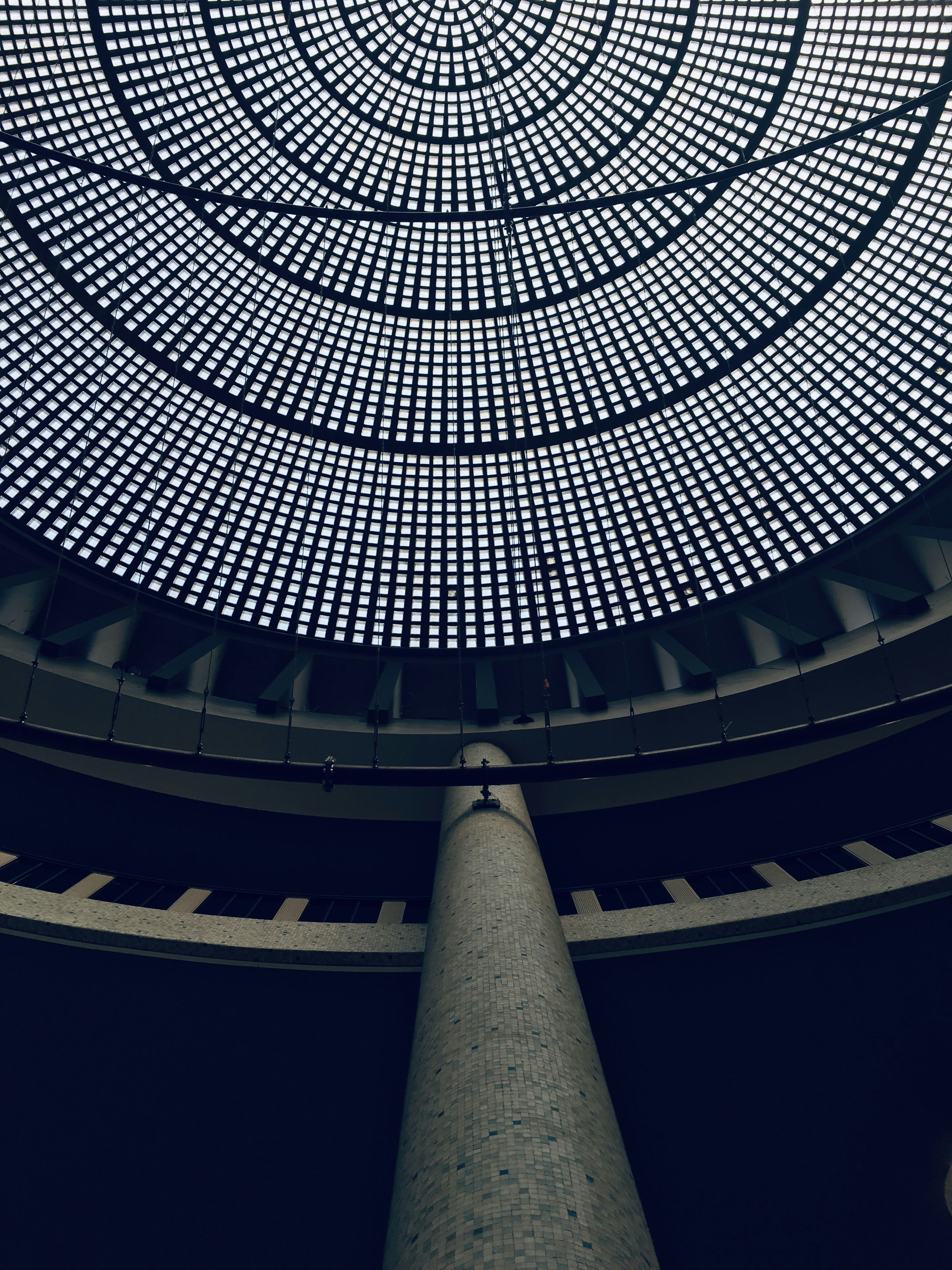 Intricate grid pattern of a skylight viewed from below, showcasing architectural elegance and modern design elements.