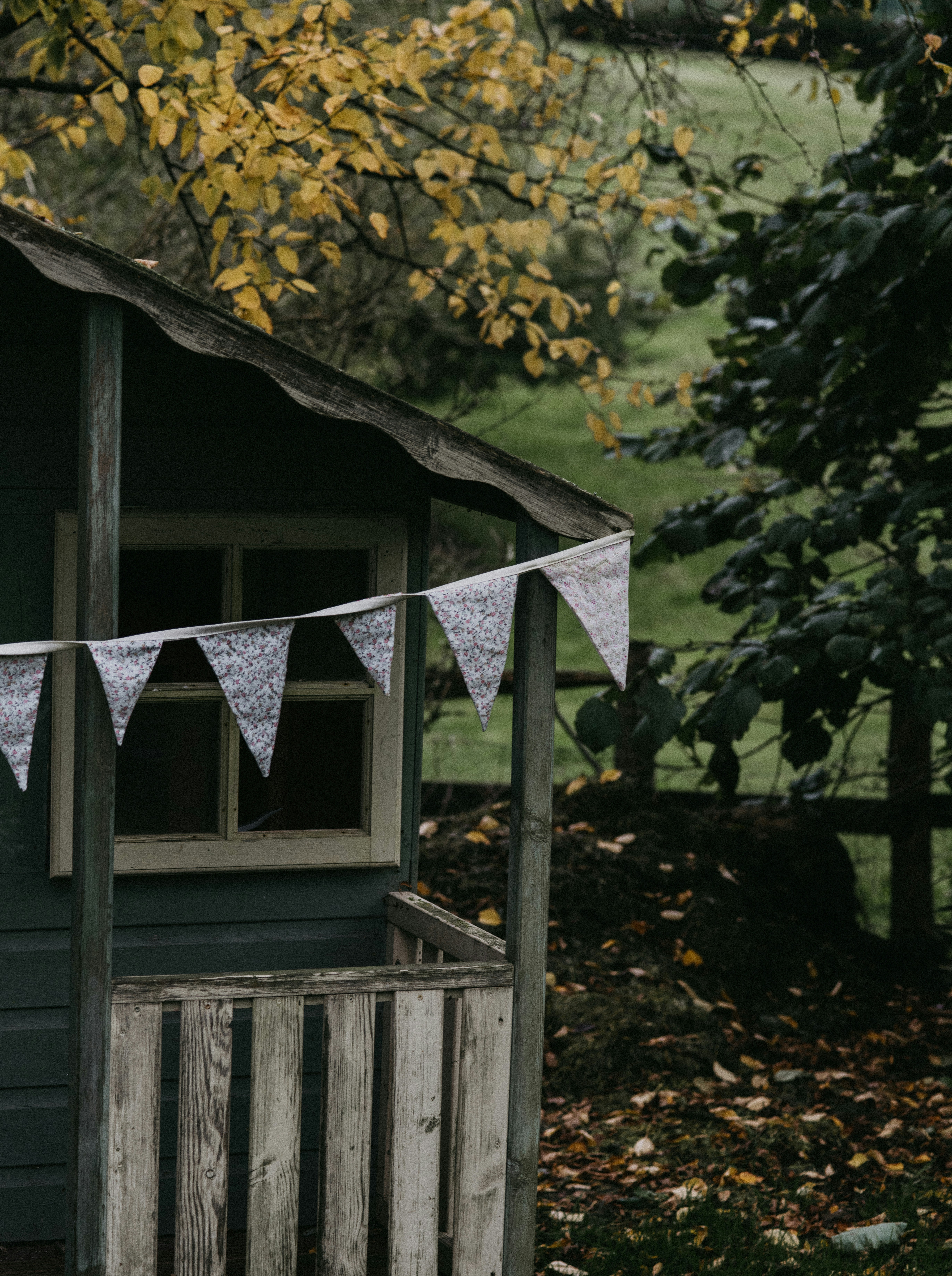 Autumn Echo: A Dated Playhouse Draped in Winding Banners