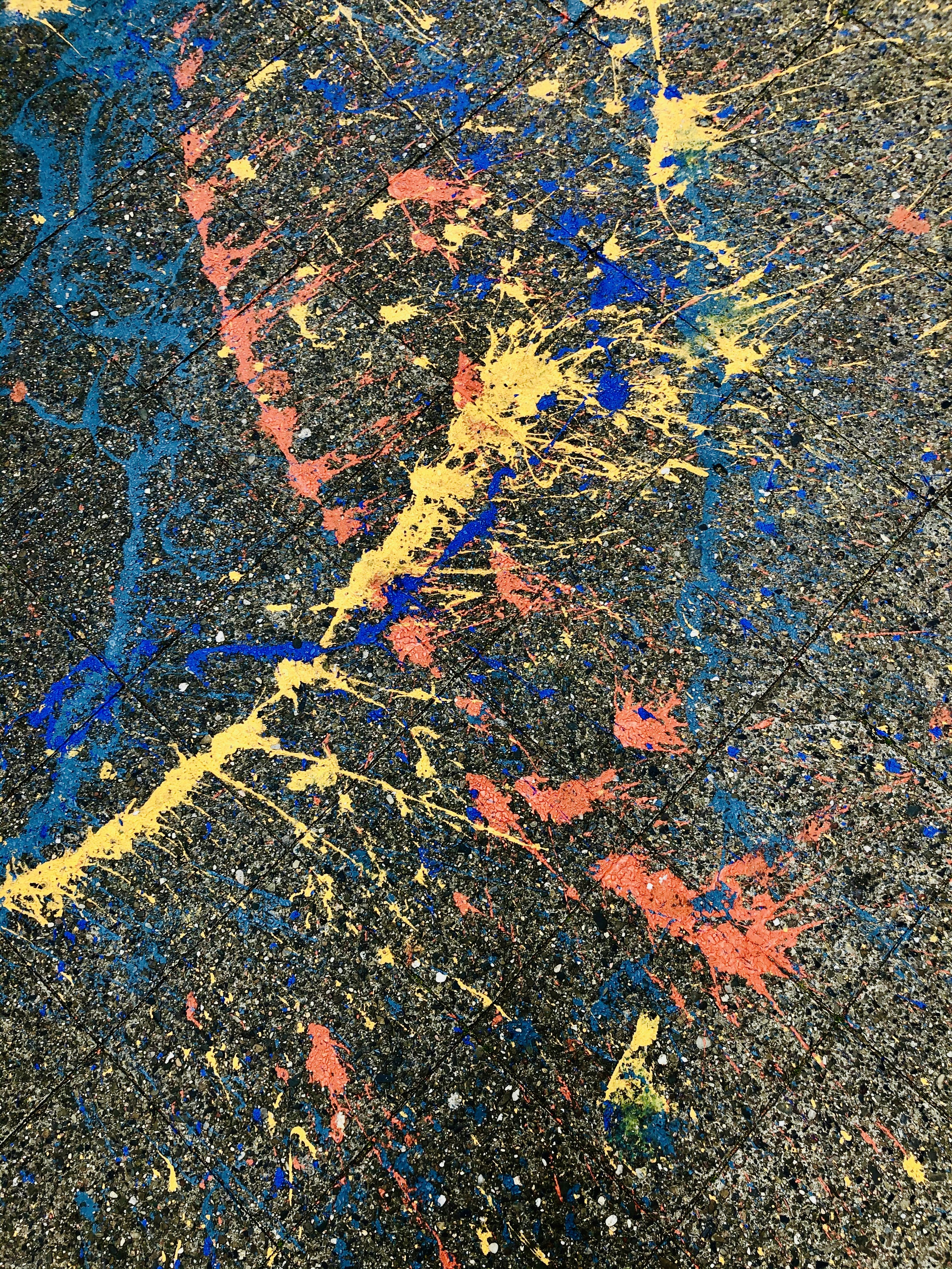Neon Drips Across Weathered Asphalt: A Burst of Color