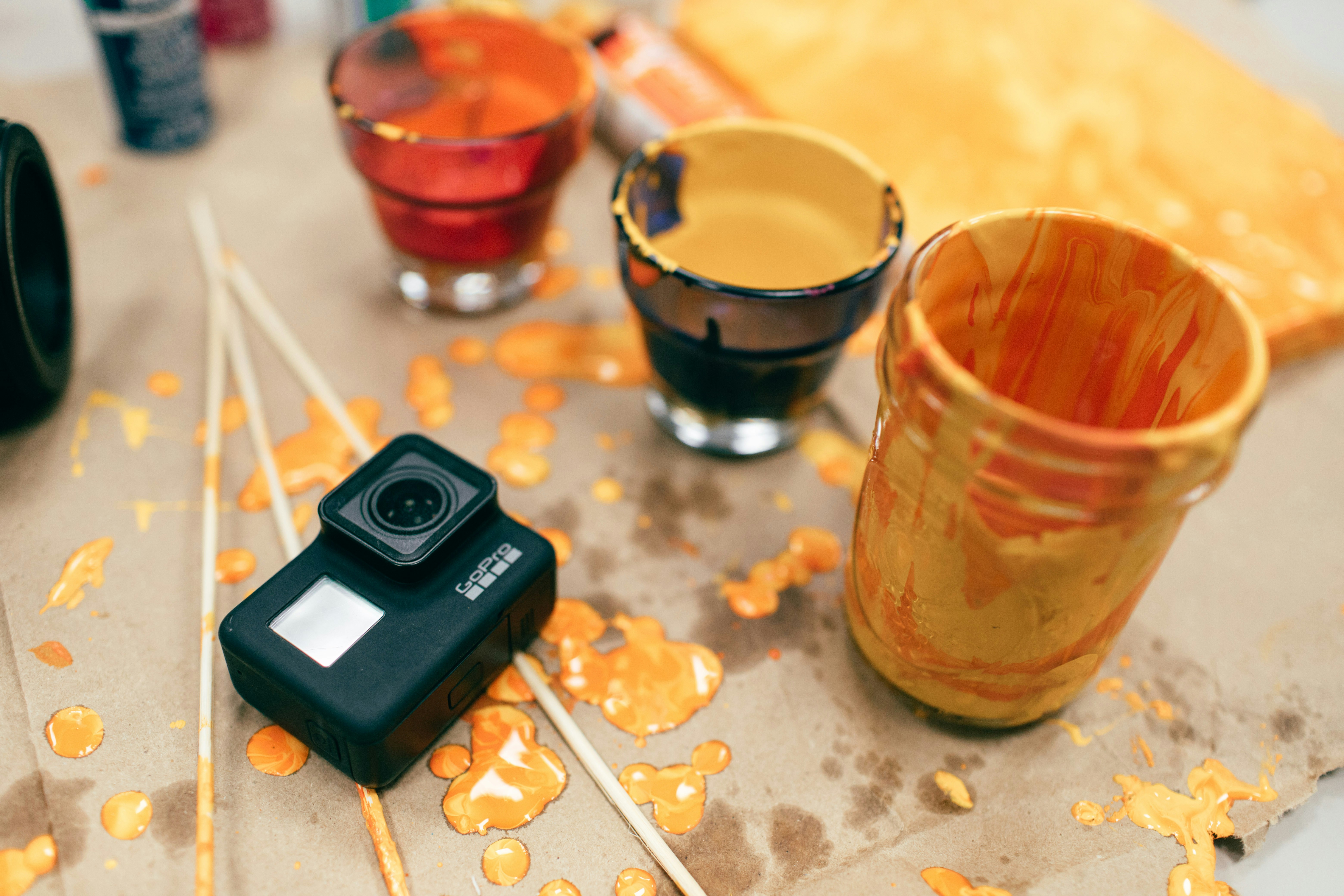 Paint-Splattered Studio: The Compact Action Cam Reclaims Focus Amid Color Chaos