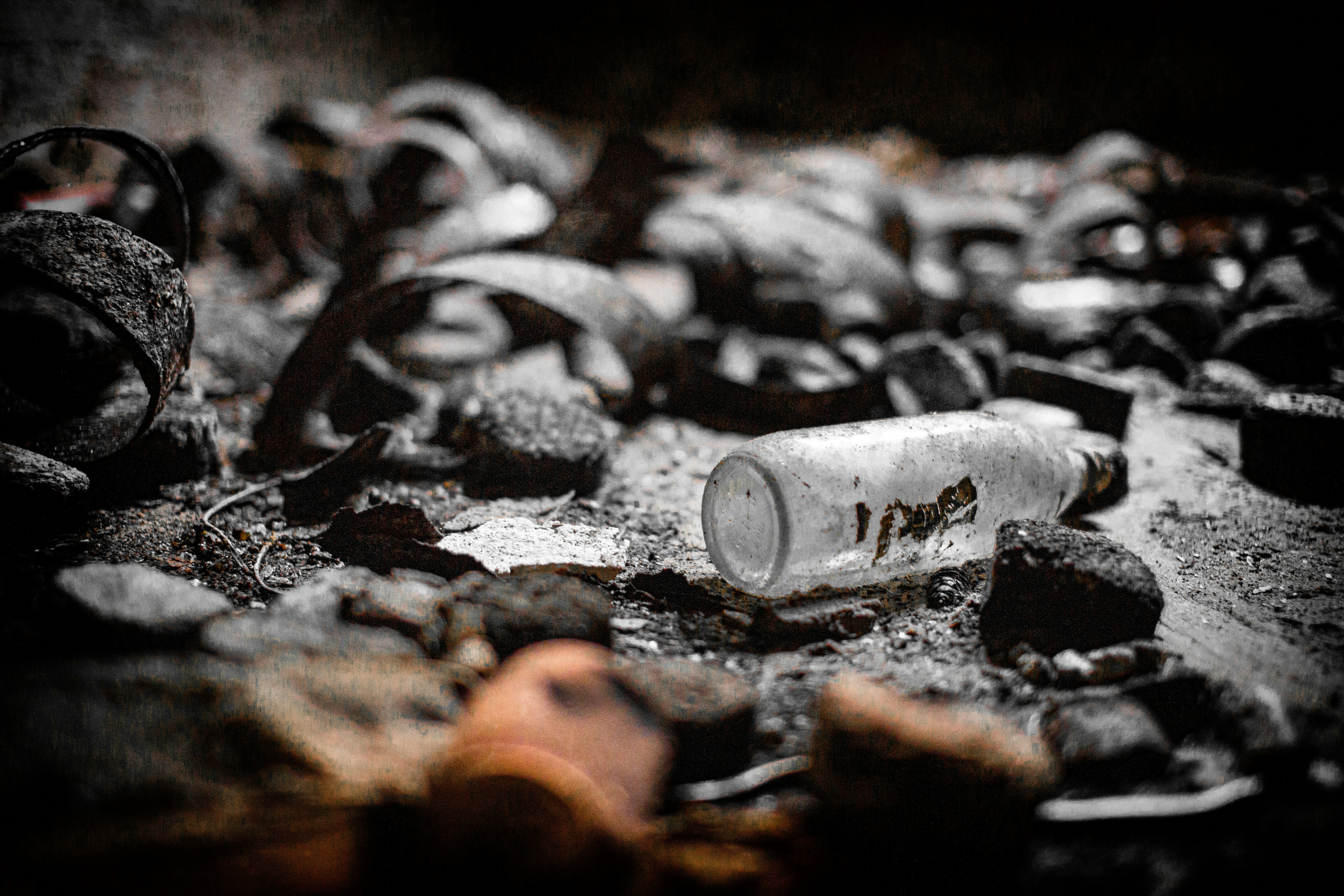 Whispered Tide: A Glass Bottle Amid Weathered Pebbles