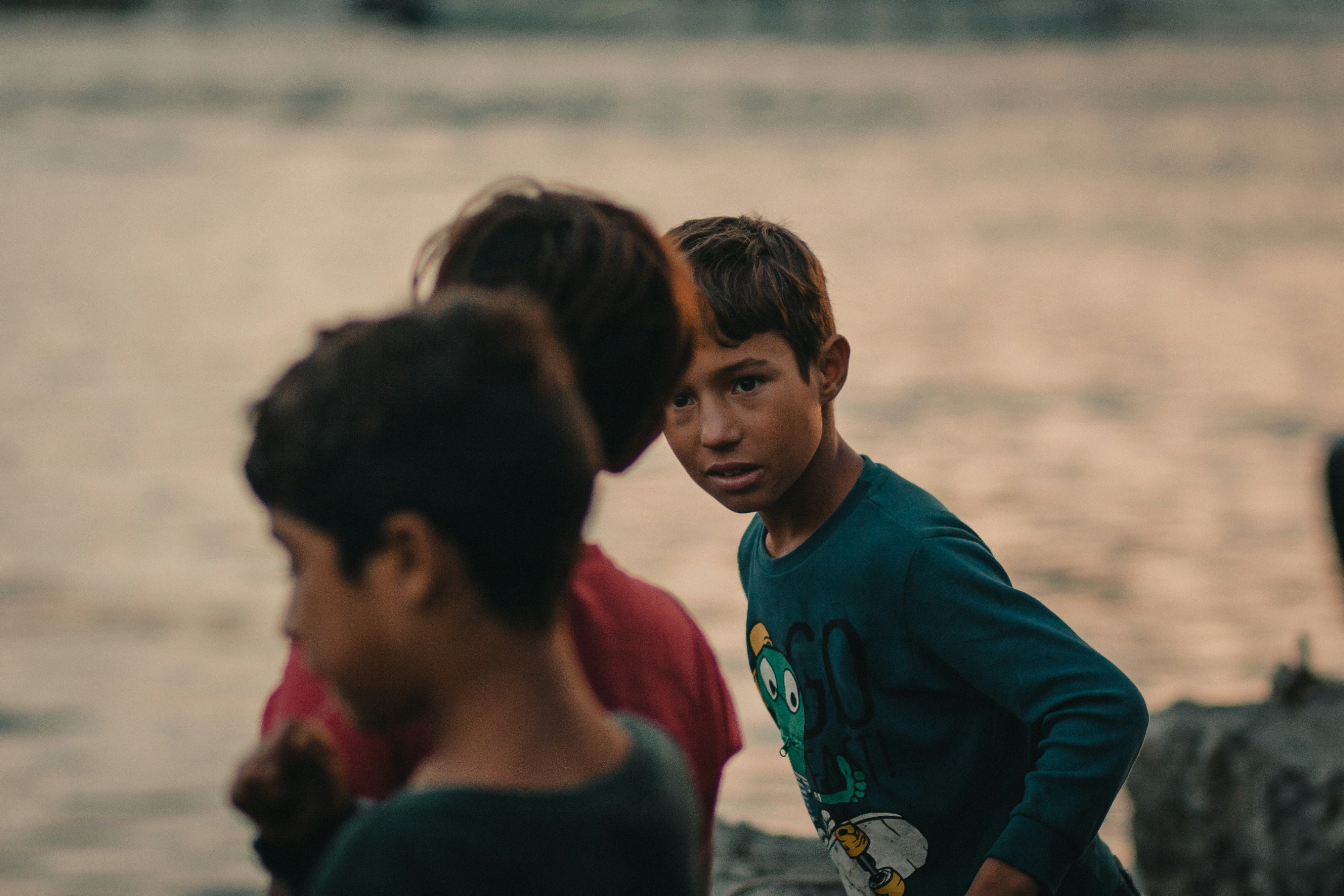 Three boys standing near body of water during daytime photo – Free ...