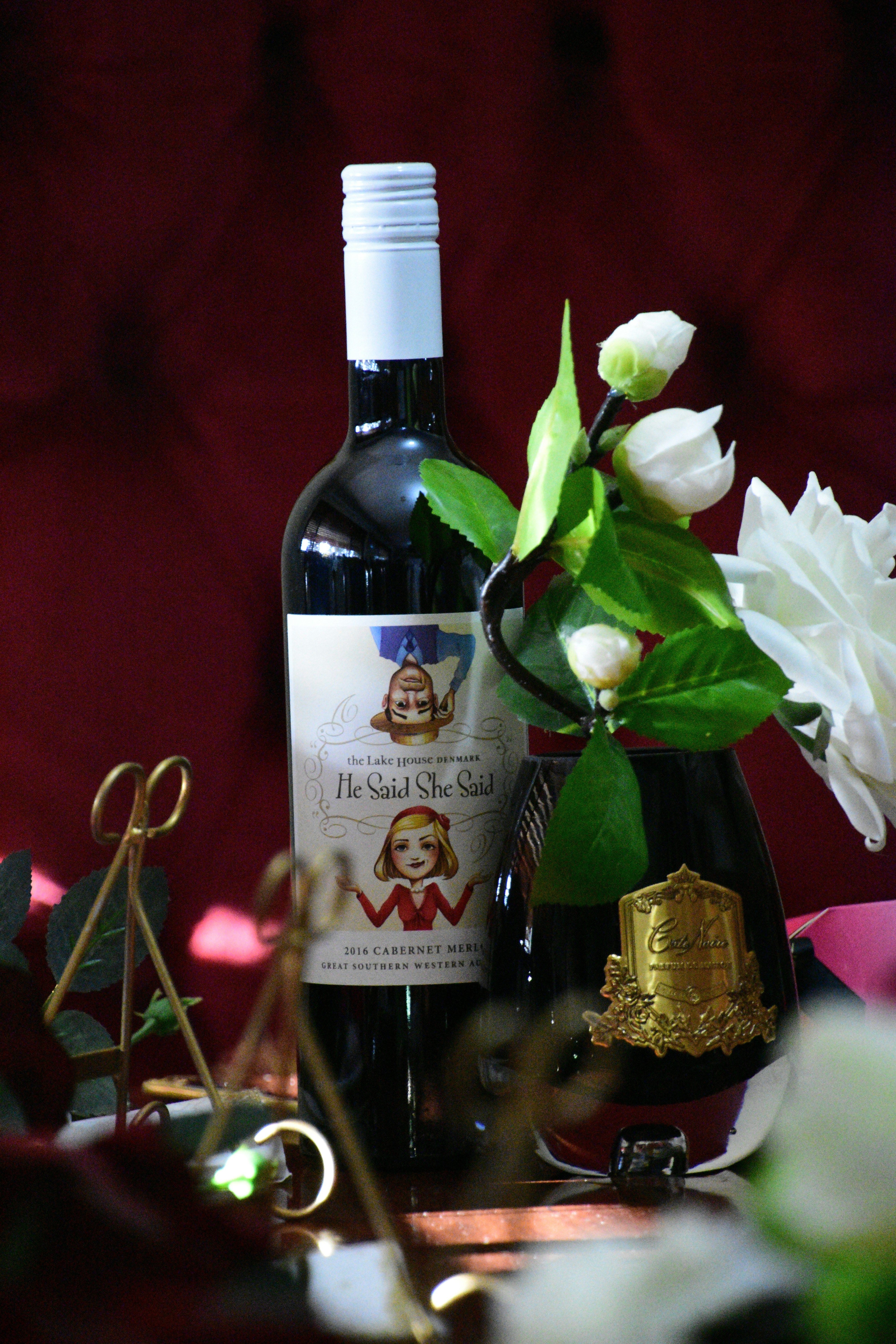 Wine Bottle Portrait amid Elegant Floral Display