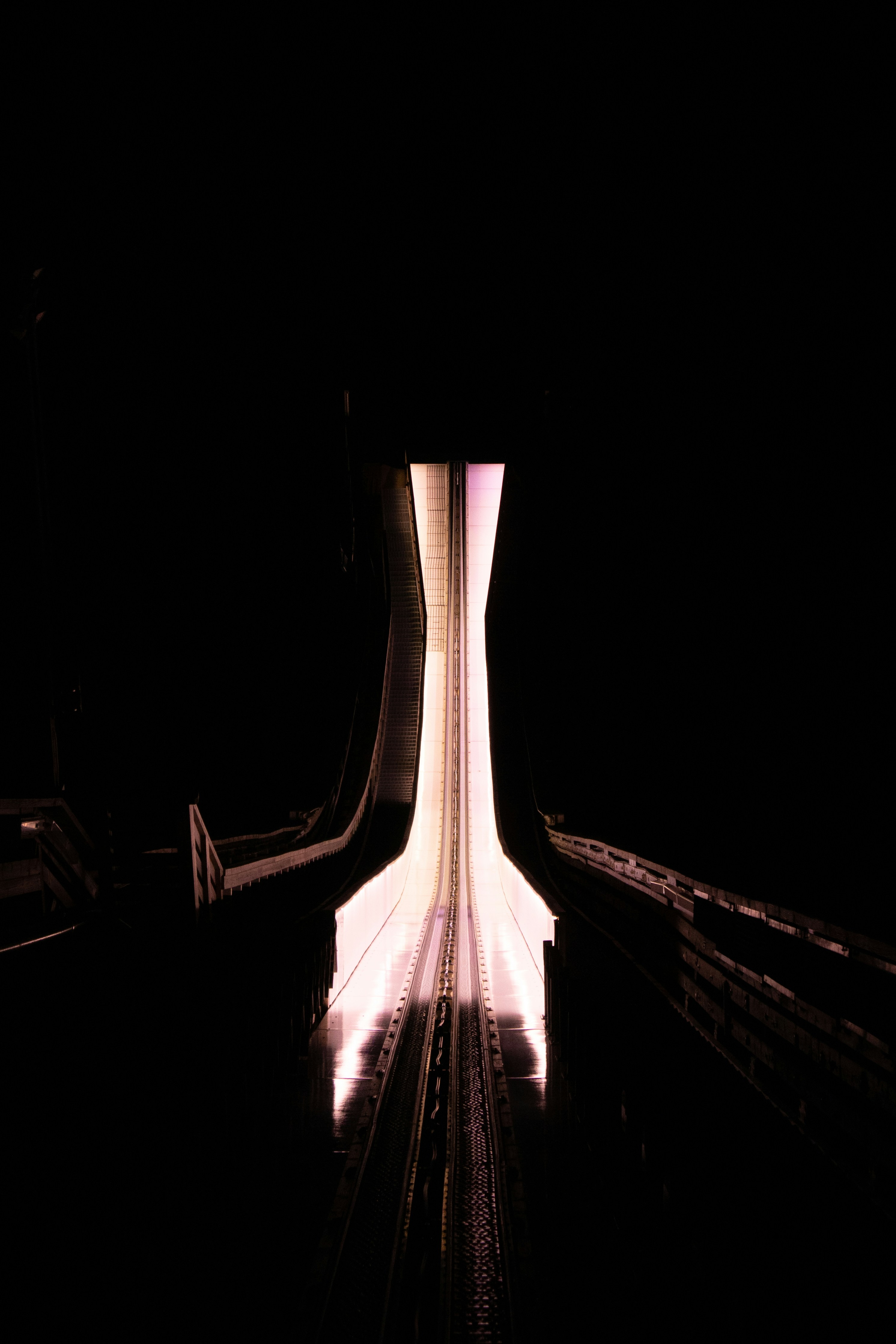 Vertical Descent: A Glowing Bridge into Darkness