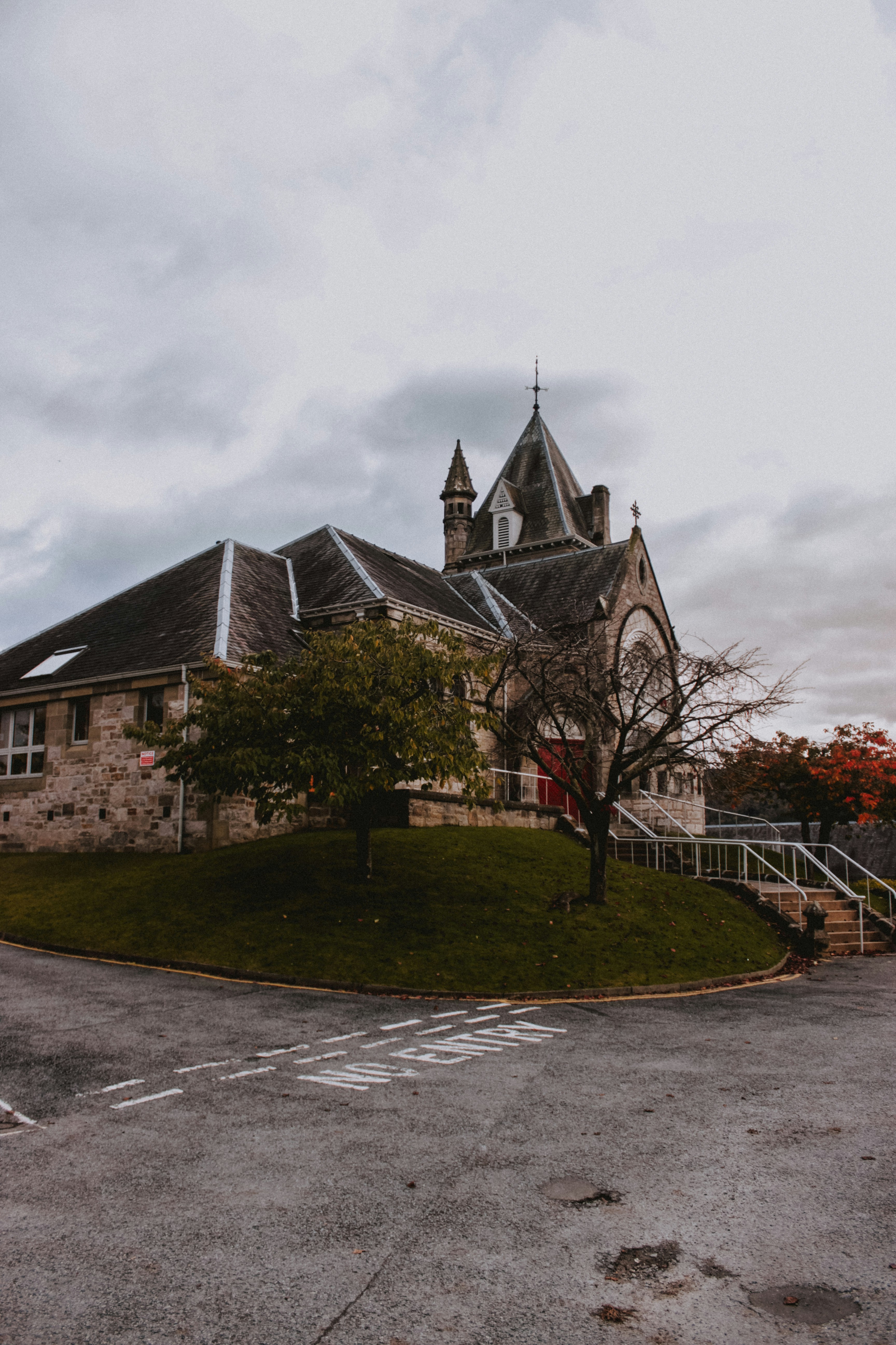Brown and gray concrete church under white and gray sky during daytime ...